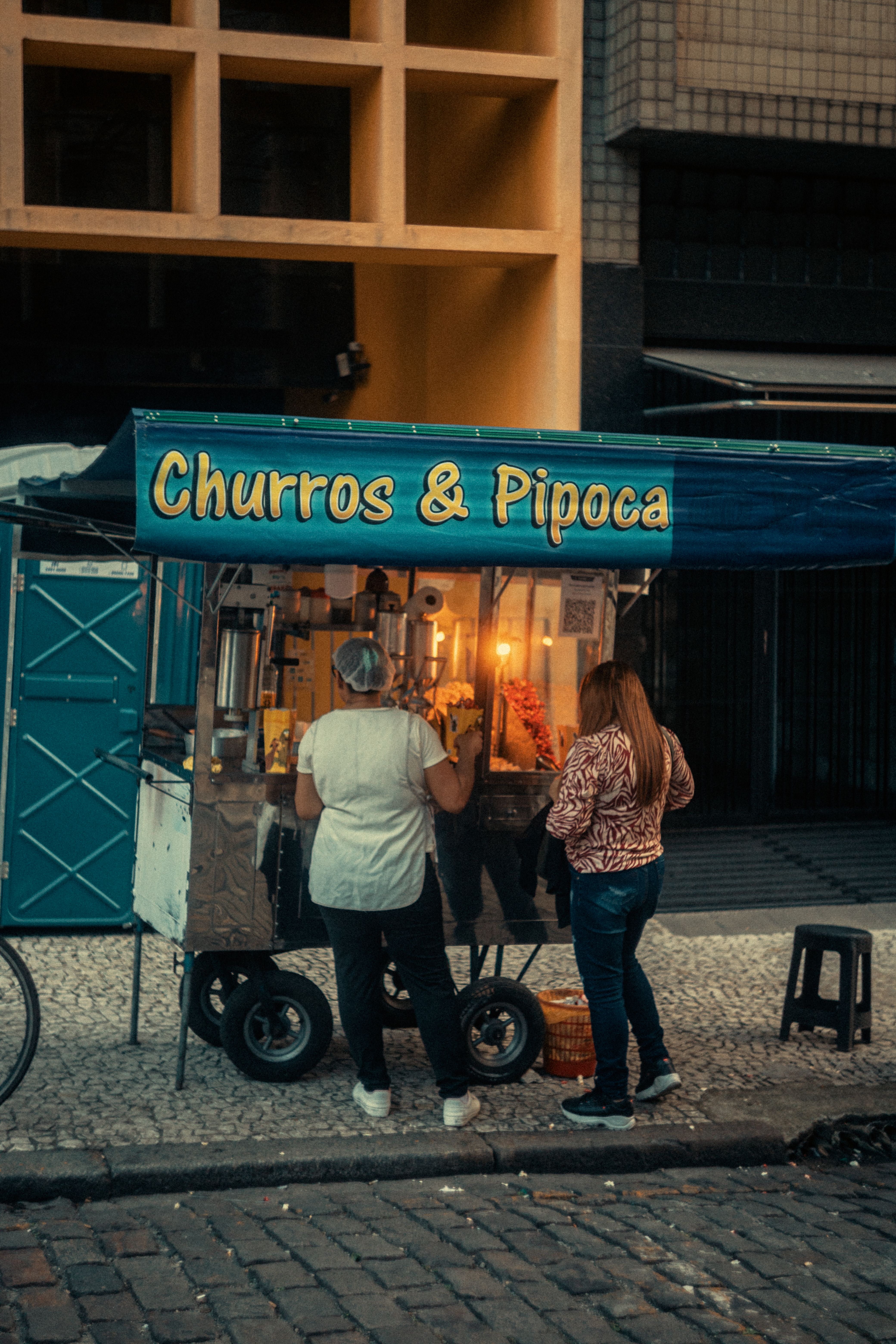 Street Vendor Selling Churros and Popcorn at Night · Free Stock Photo