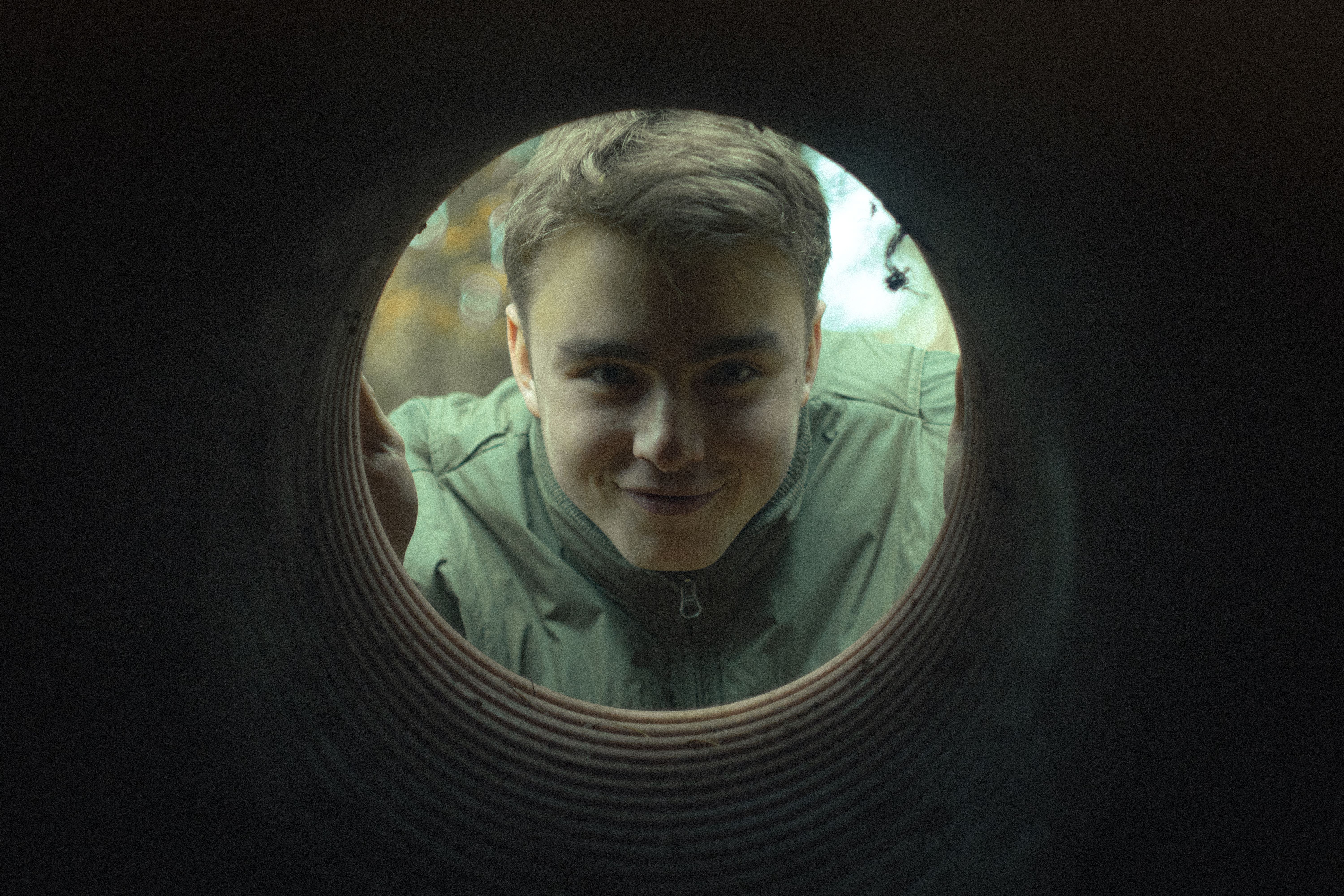 Youthful male expression through a round frame · Free Stock Photo