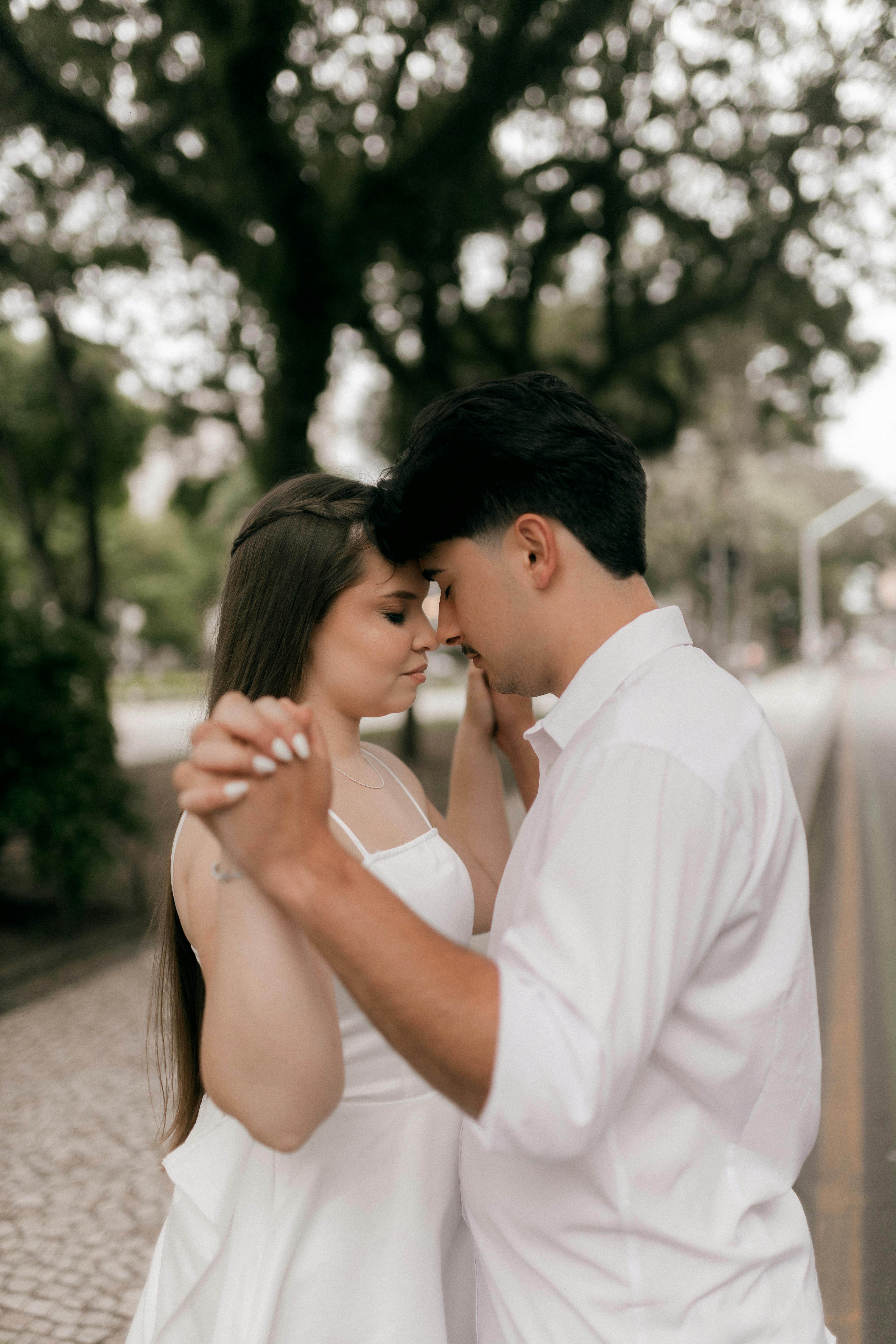 Romantic Couple Dancing Outdoors in Park Setting · Free Stock Photo