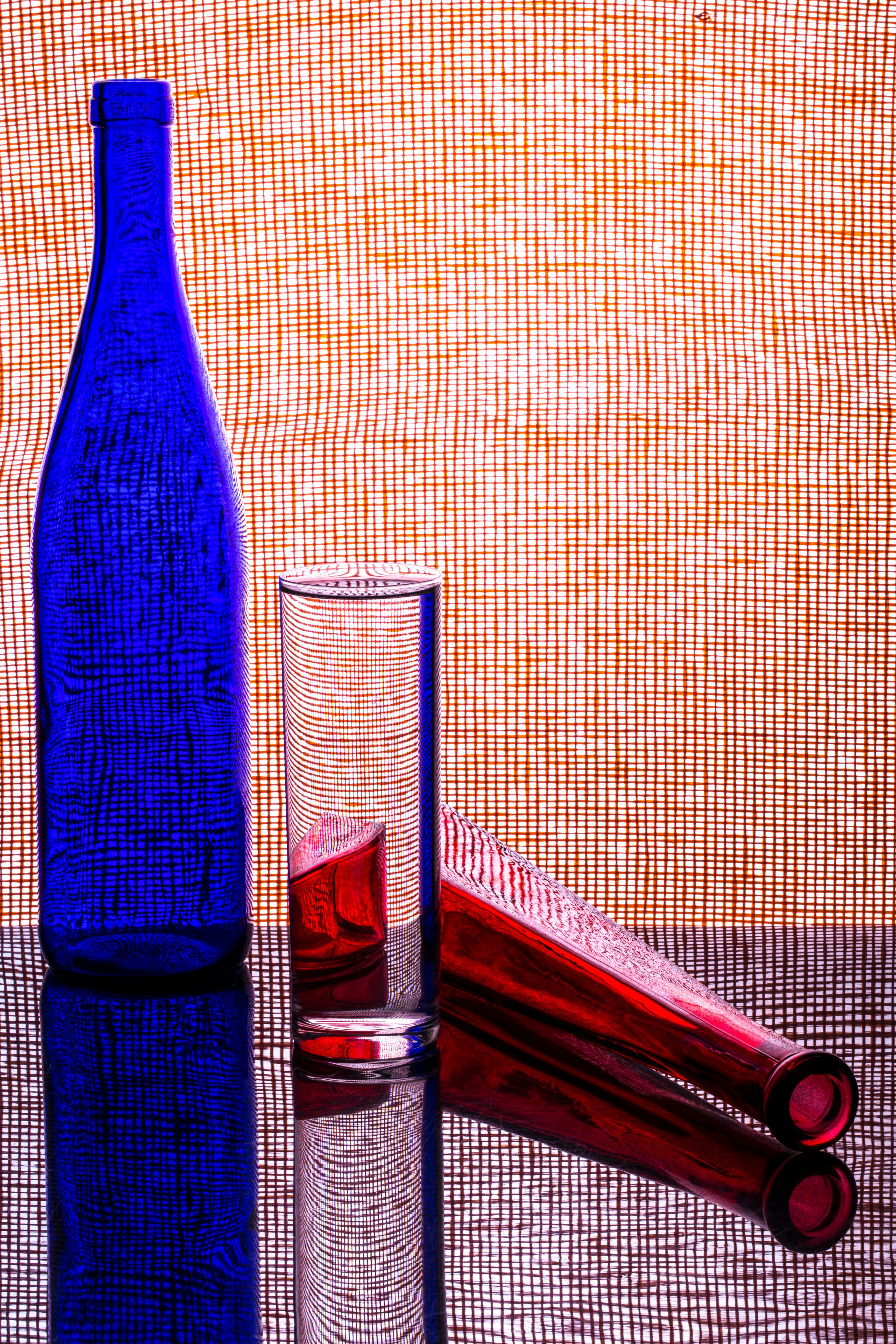 Colorful Still Life with Glass Bottles and Reflections · Free Stock Photo