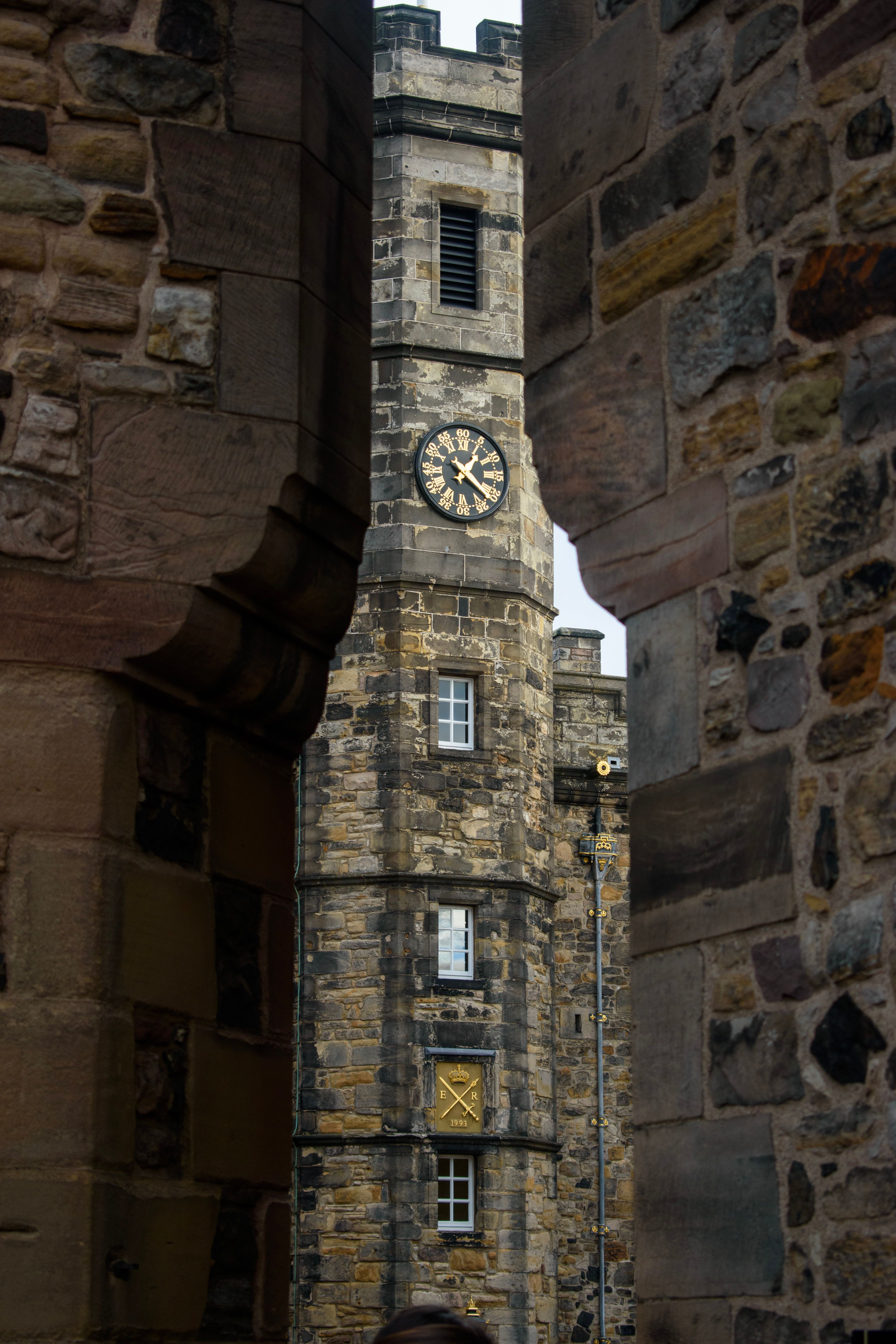 Historic Stone Clock Tower Framed by Old Walls · Free Stock Photo