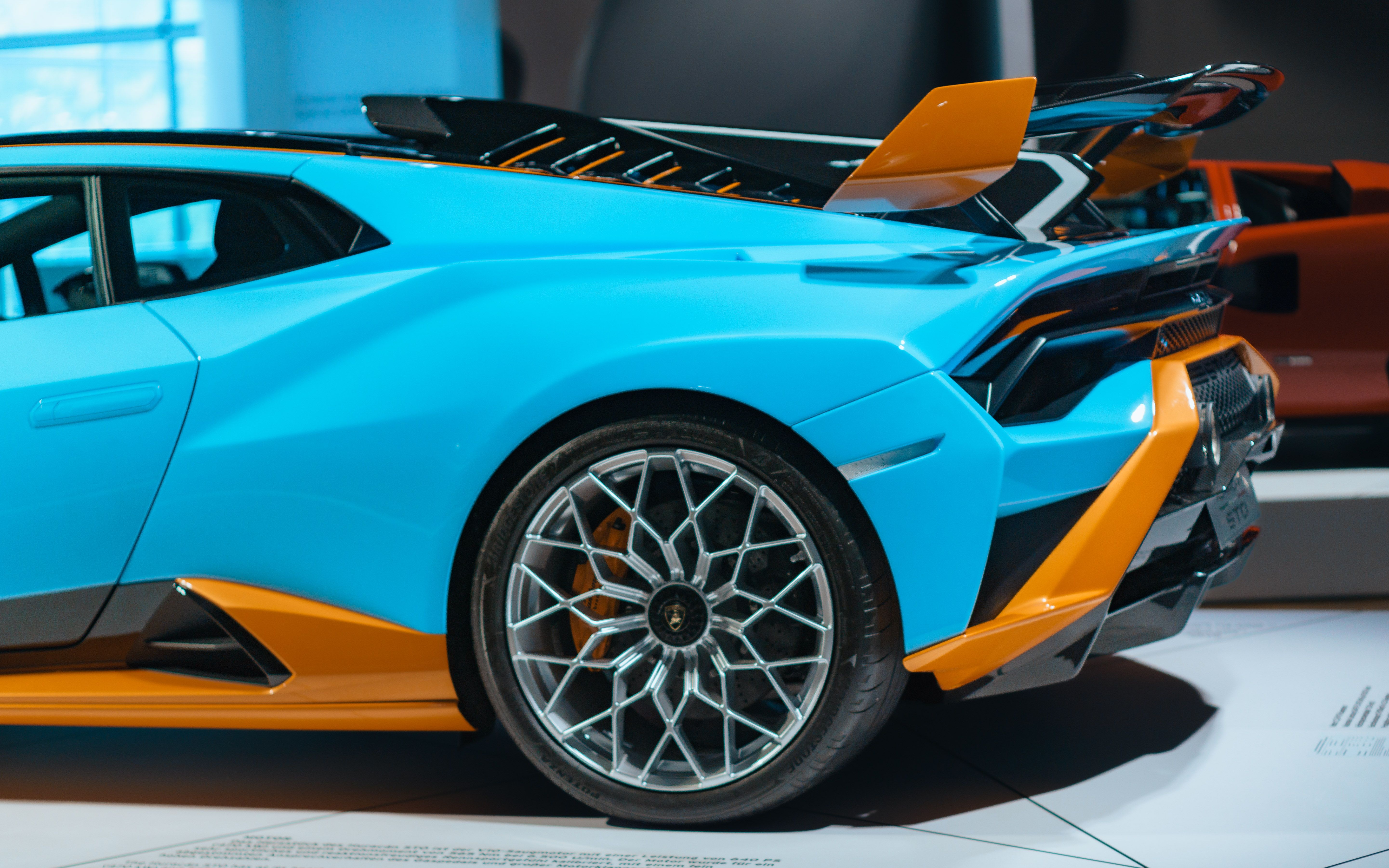 Vibrant Blue Sports Car with Orange Accents · Free Stock Photo