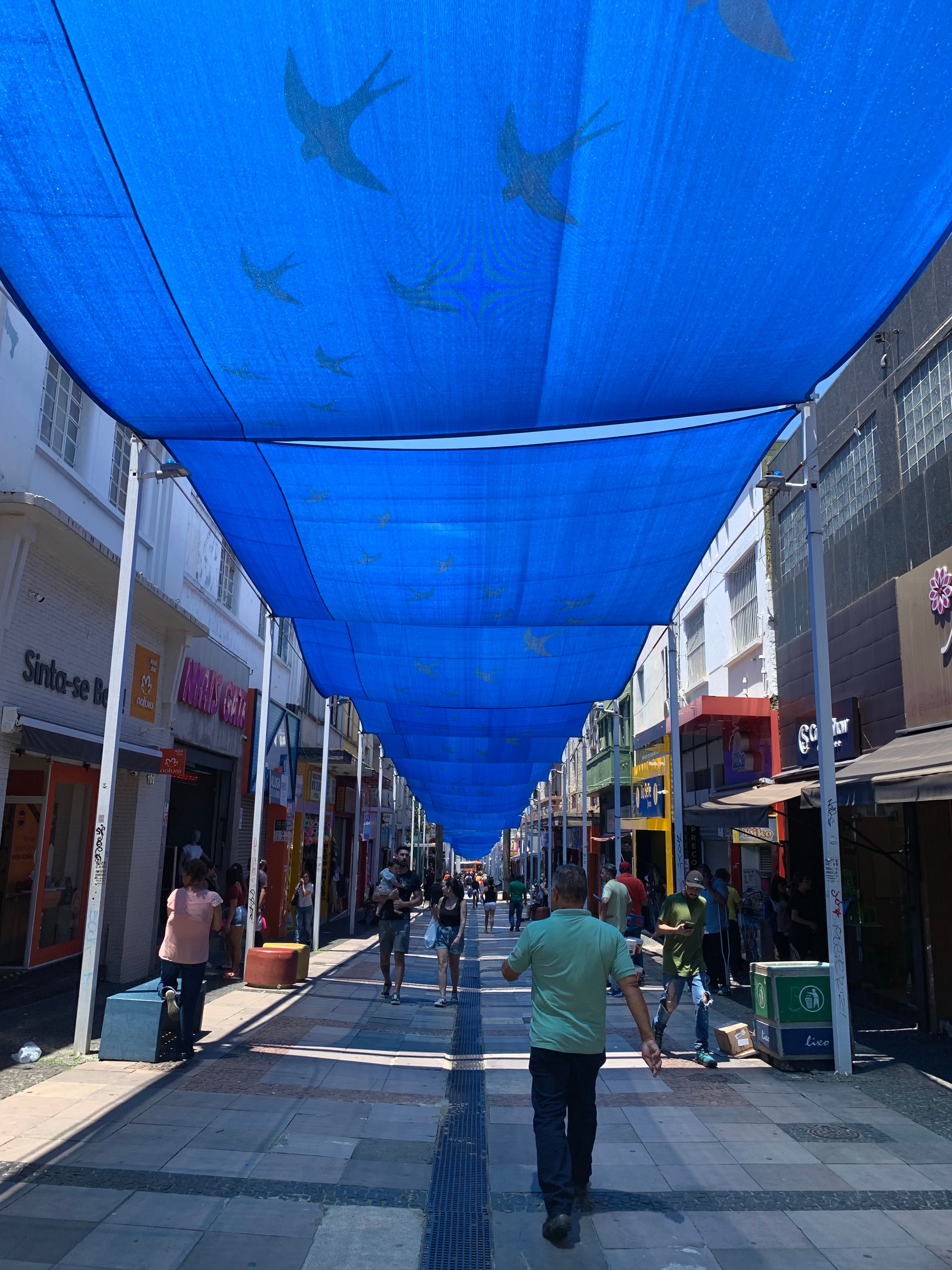 Vibrant Street Under Blue Canopy in Daylight · Free Stock Photo