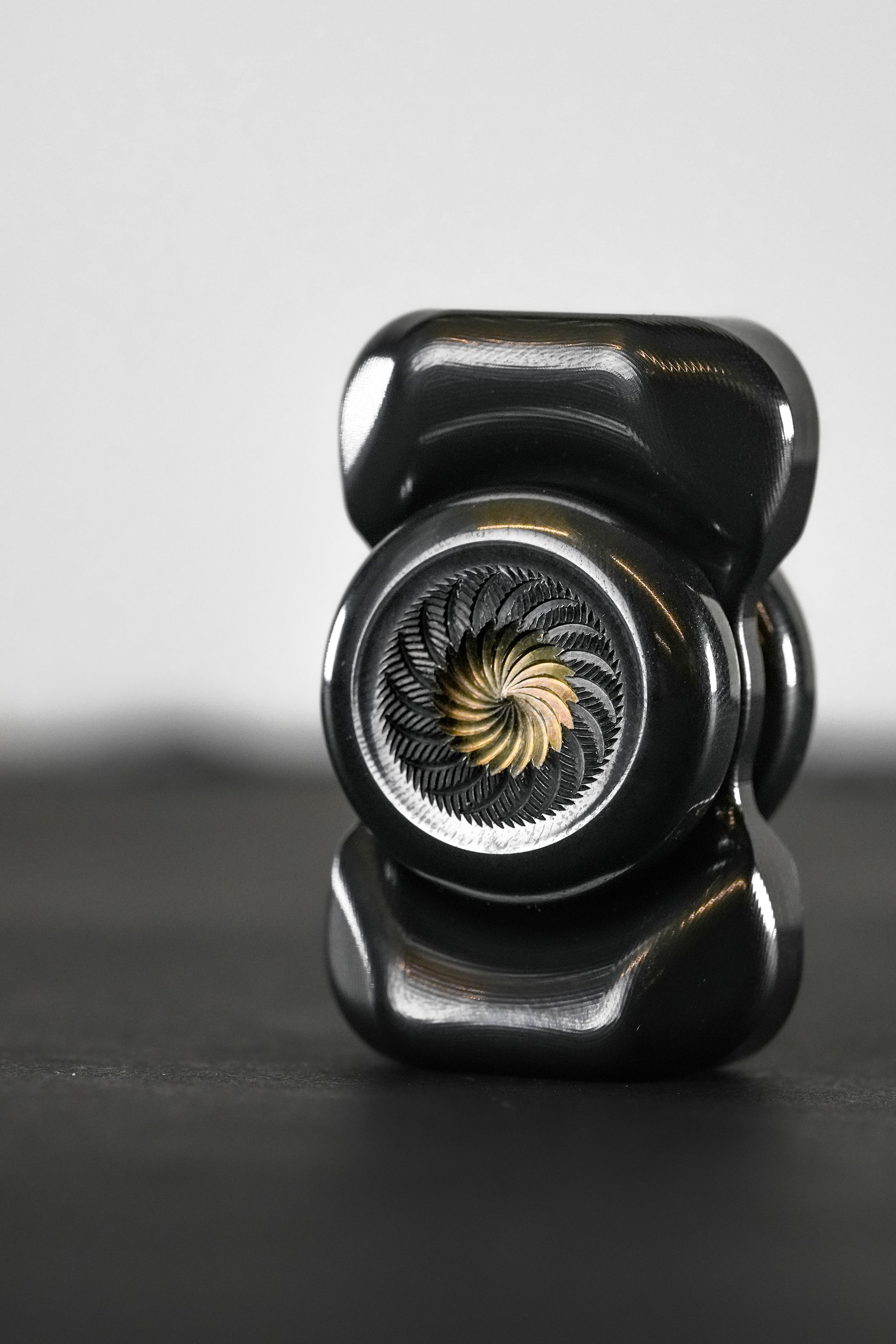 Close-Up of a Modern Fidget Spinner on Black Surface · Free Stock Photo