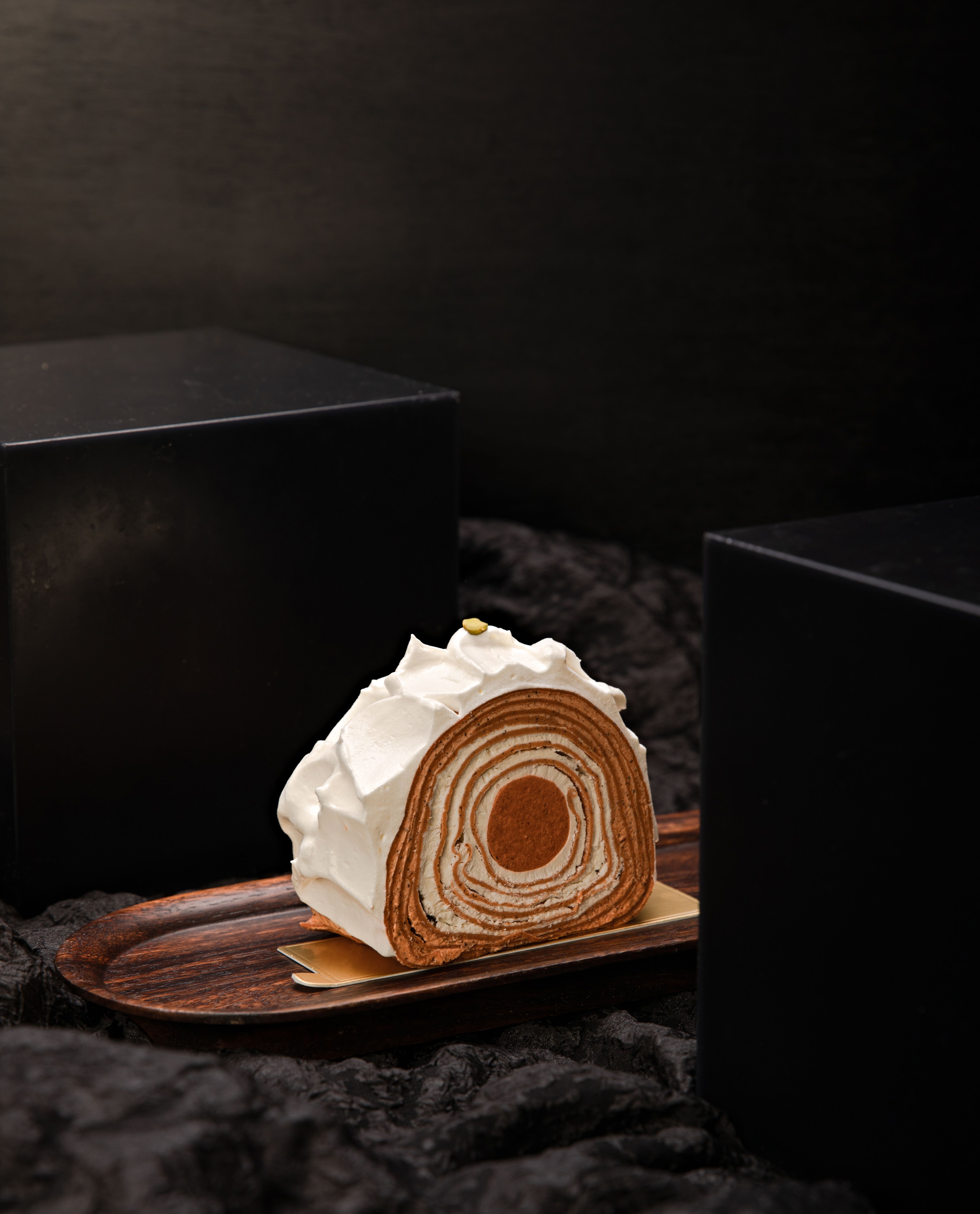 Elegant Rolled Cake with Whipped Cream Topping · Free Stock Photo