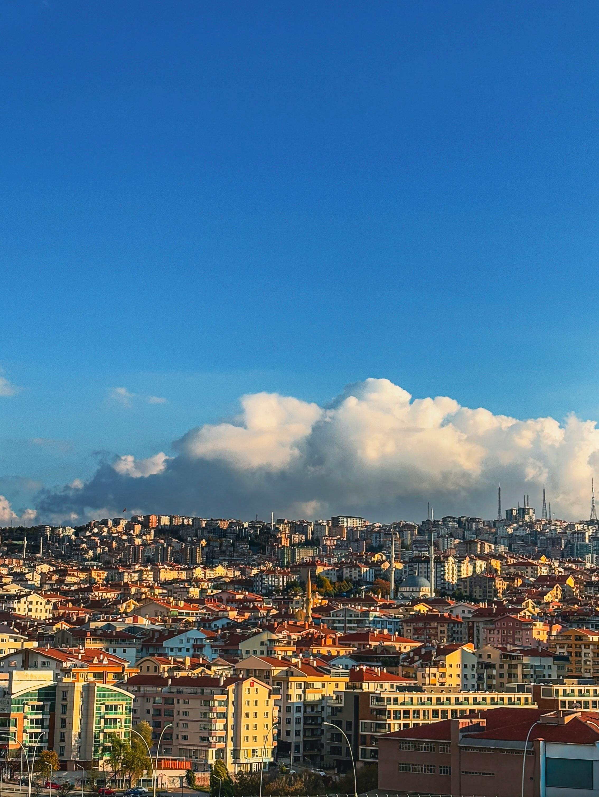 Aerial View of Urban Landscape with Puffy Clouds · Free Stock Photo