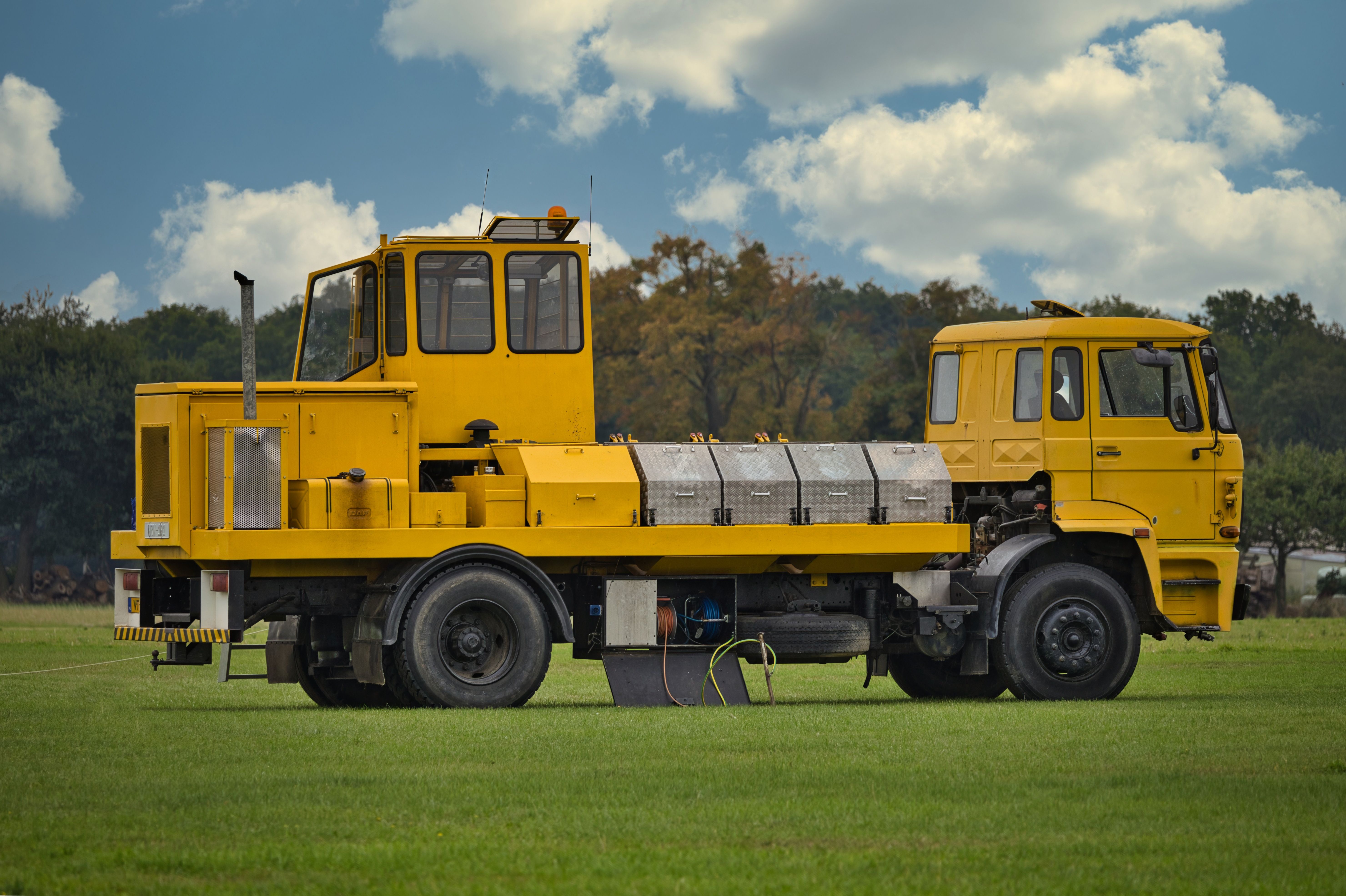 Yellow Industrial Vehicle on Green Field Landscape · Free Stock Photo