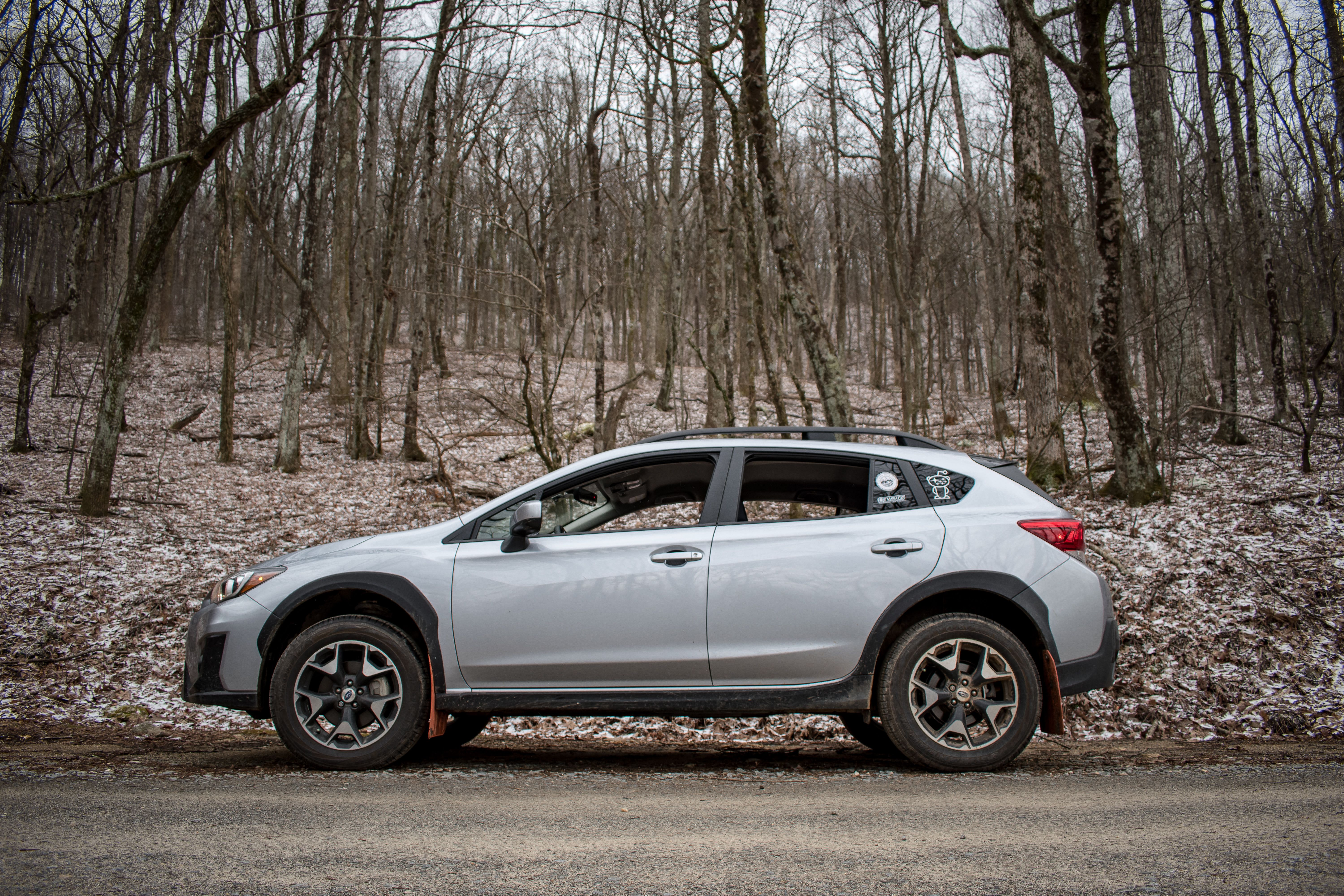 Compact SUV in Winter Forest Landscape · Free Stock Photo