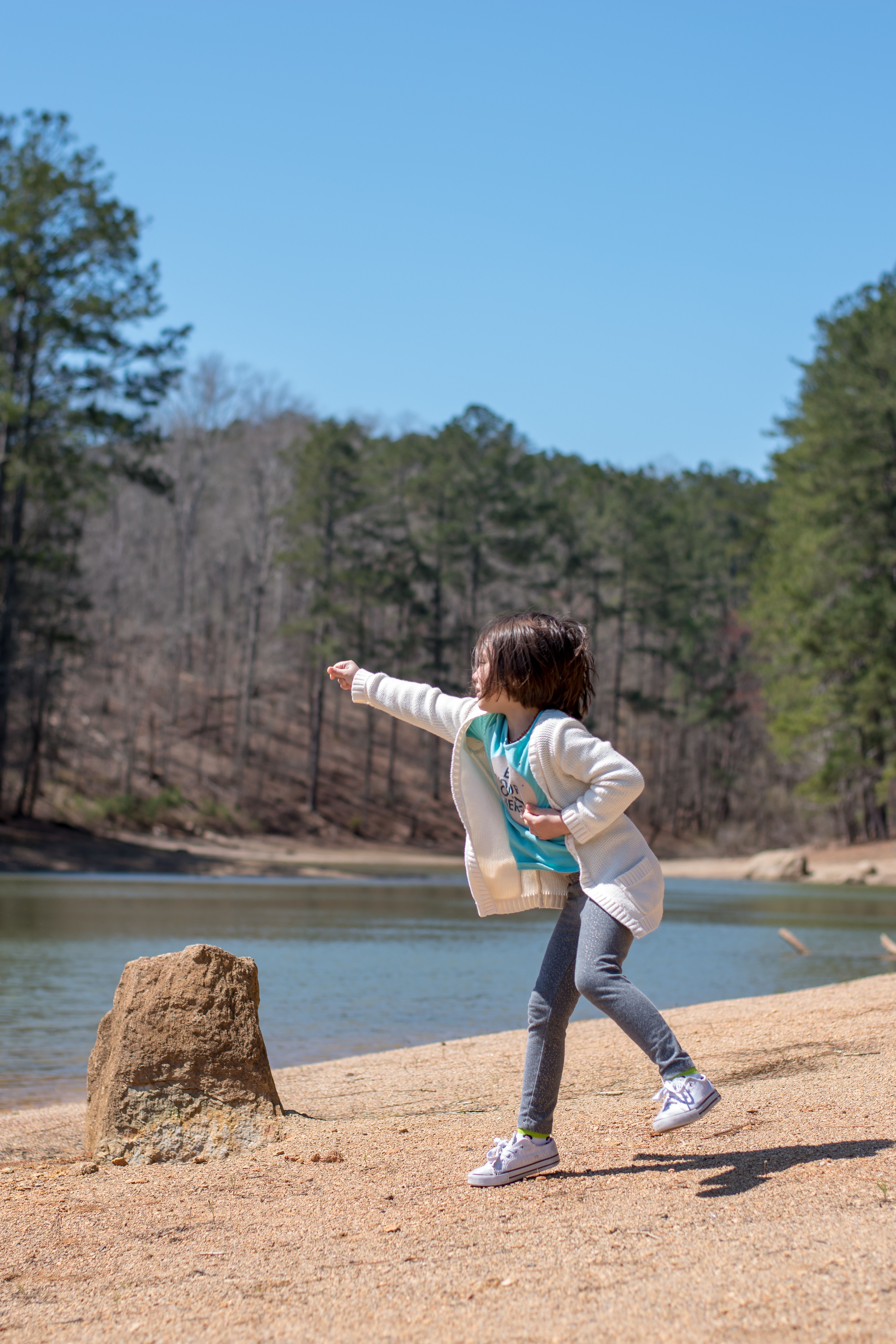 Child Playing on Lakeshore in Springtime · Free Stock Photo