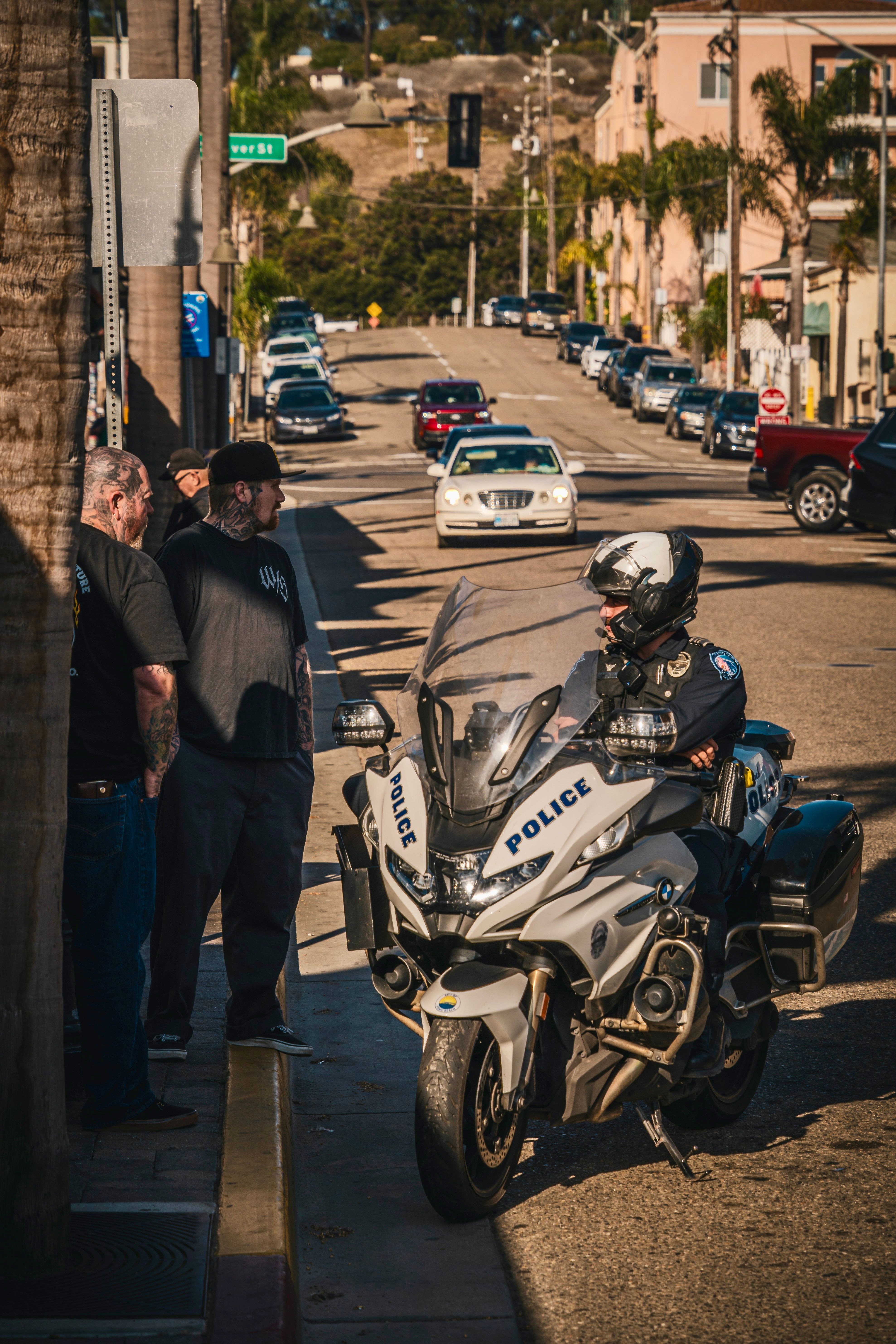 Police Officer on Motorcycle in Urban Street Scene · Free Stock Photo