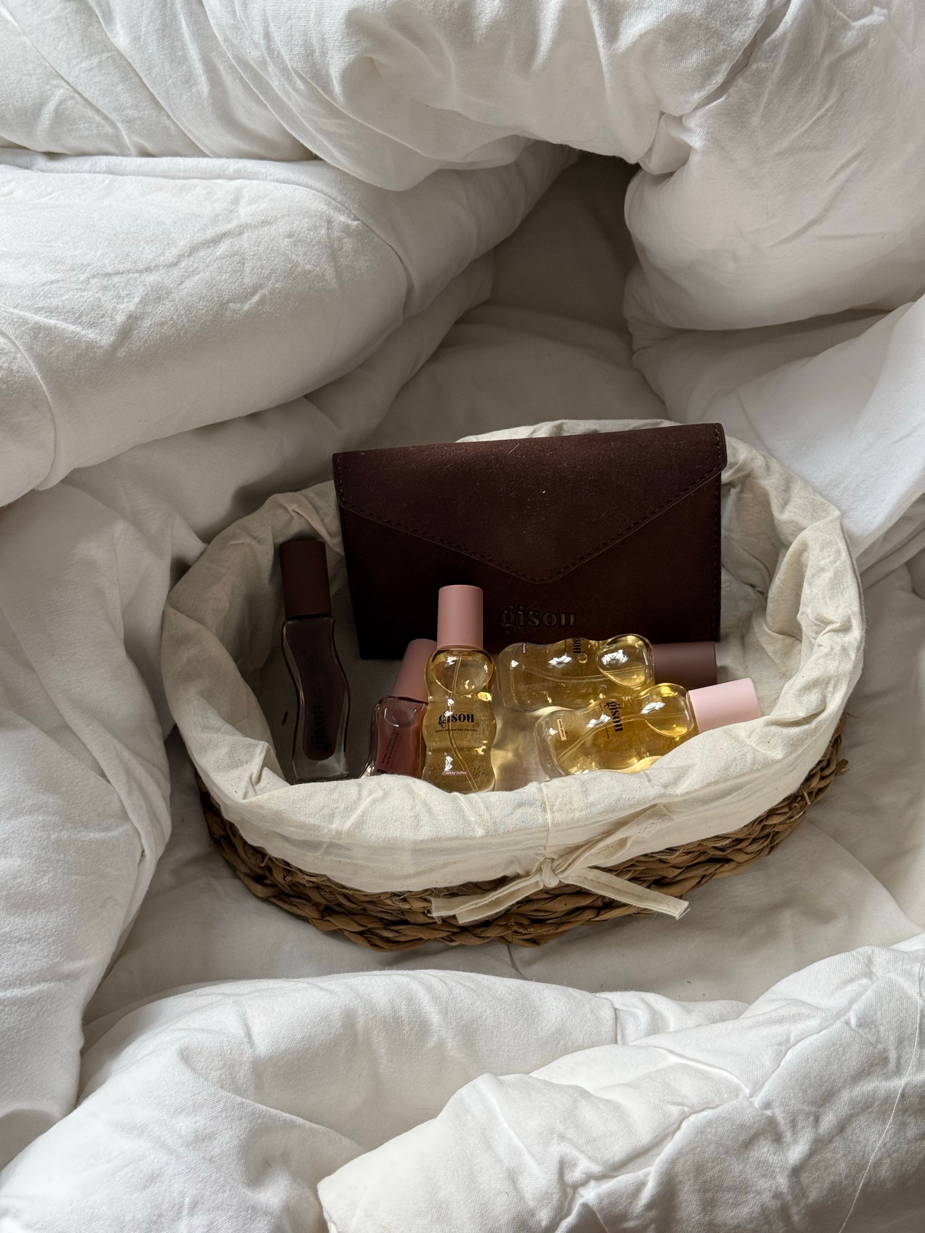 Cozy Basket with Essential Oil Bottles on Bed · Free Stock Photo