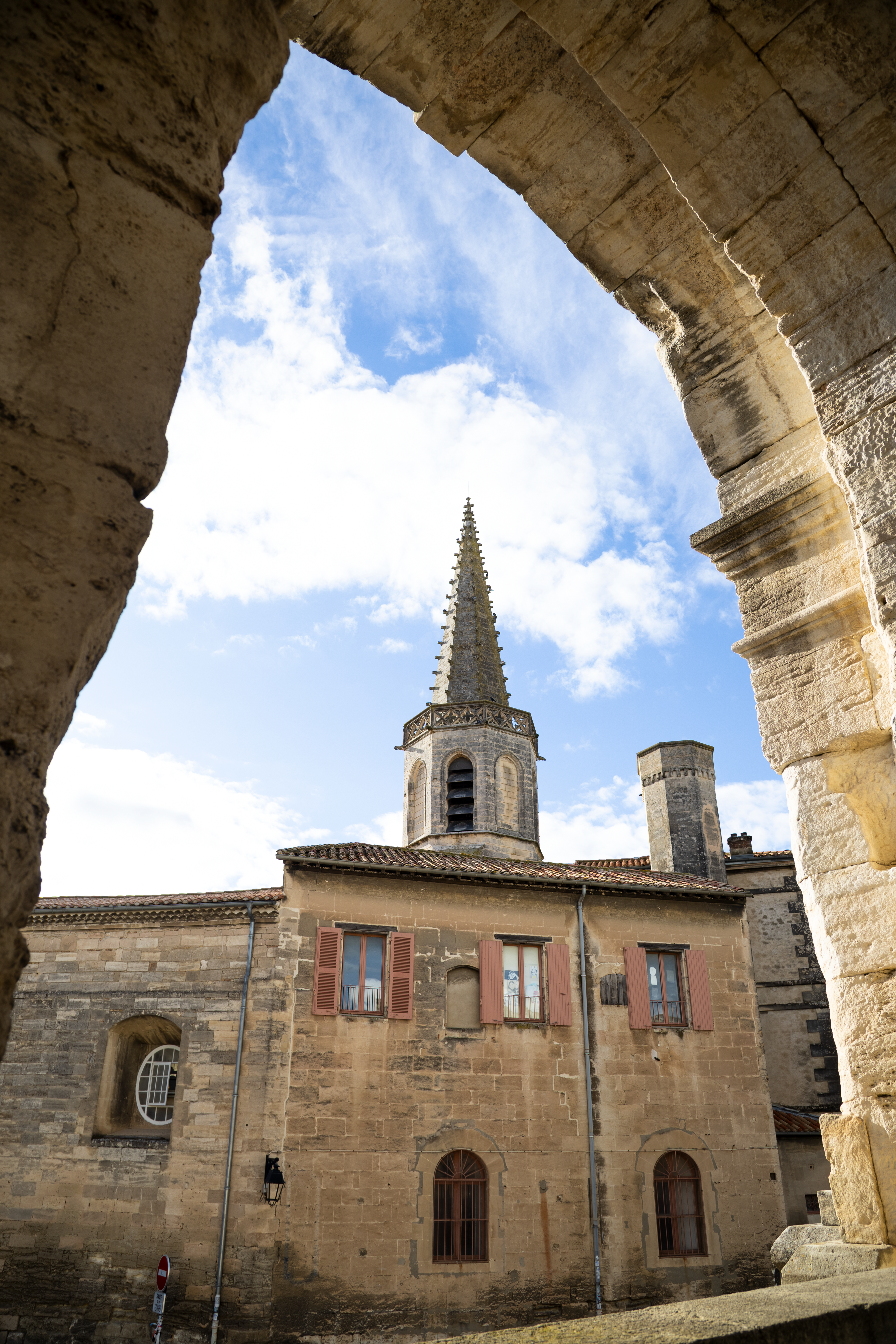 Medieval Church Spire Framed by Stone Archway · Free Stock Photo