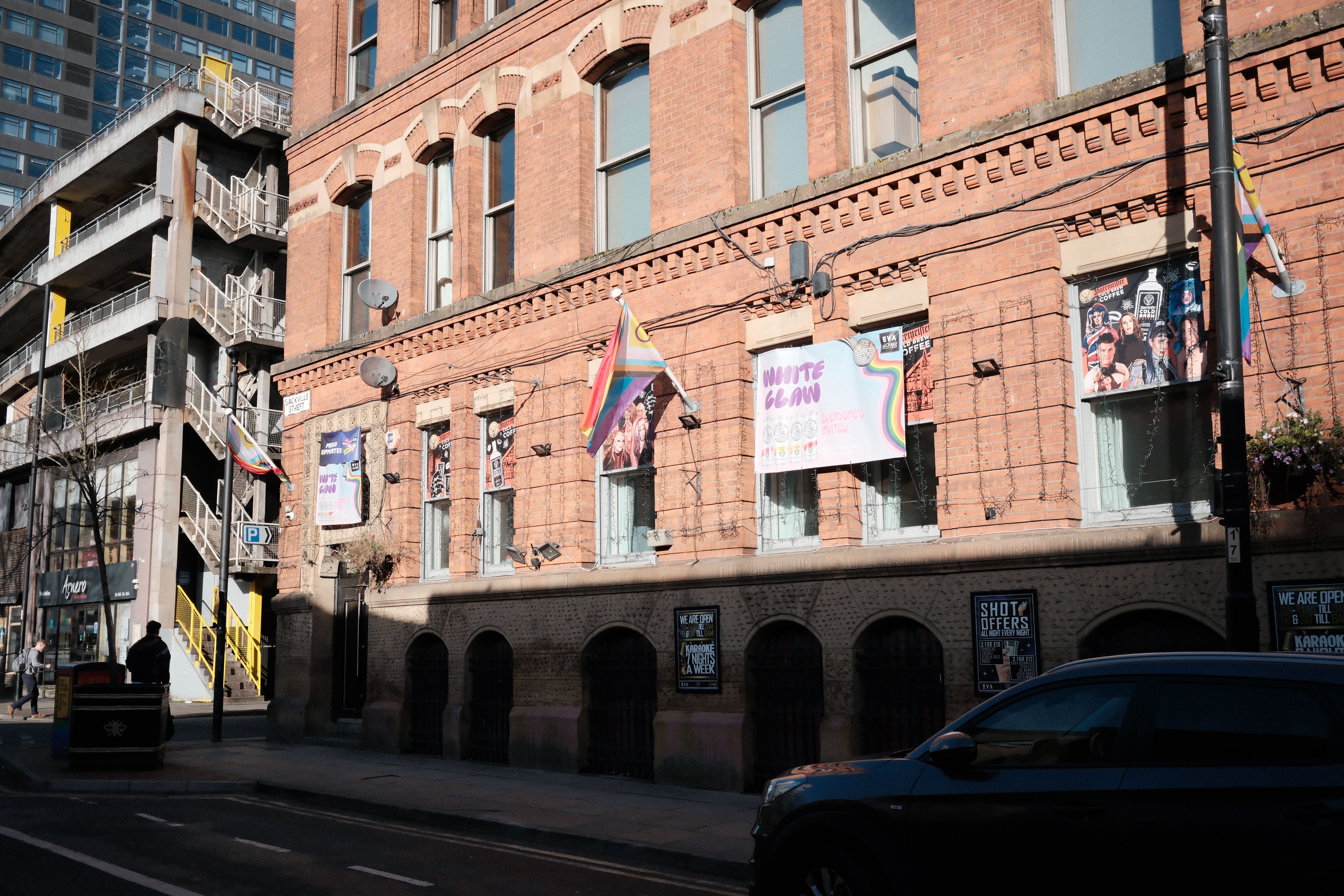 Urban street view with LGBTQ flags and posters · Free Stock Photo