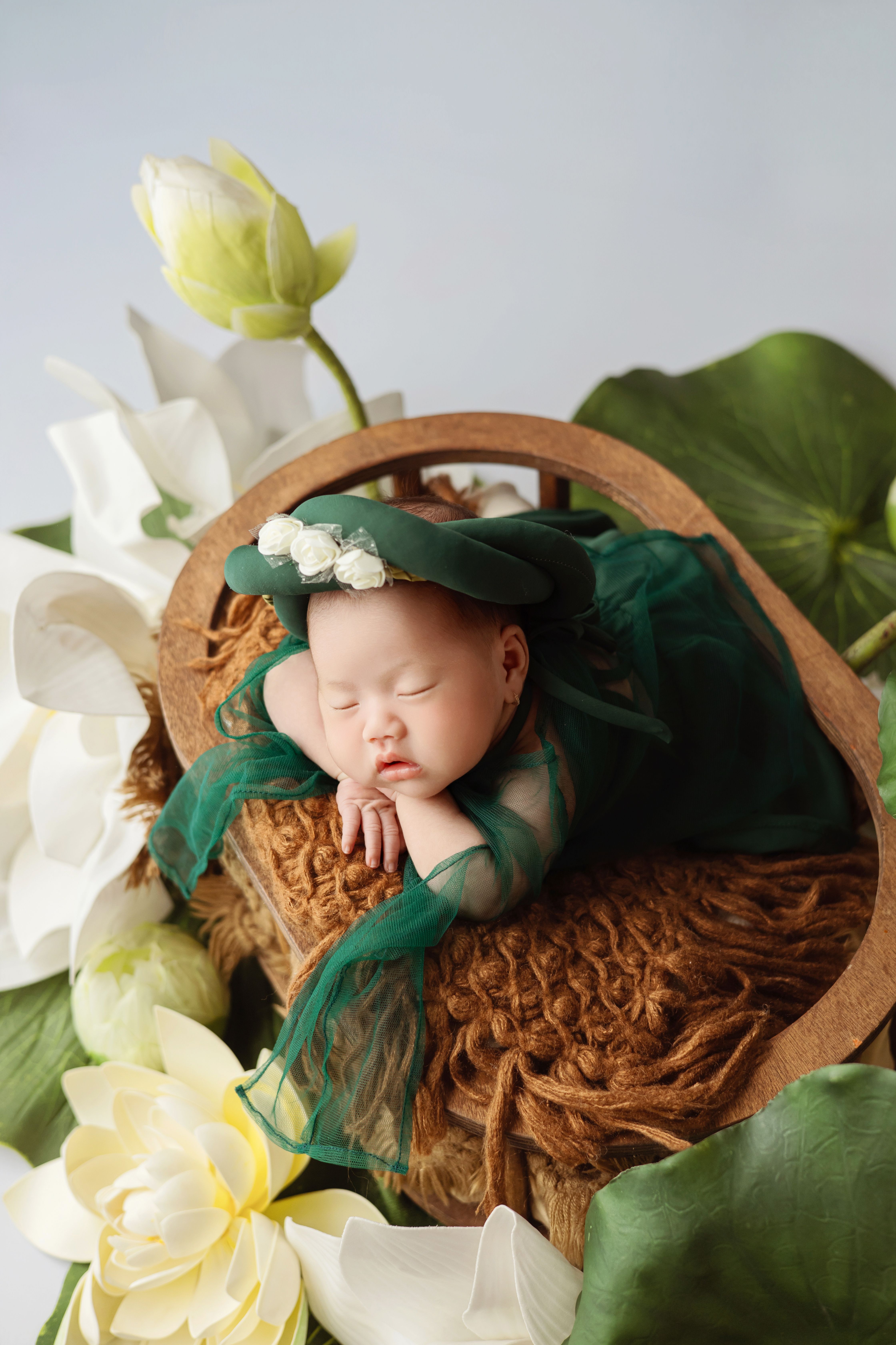 Adorable Newborn Sleeping Among Lotus Flowers · Free Stock Photo