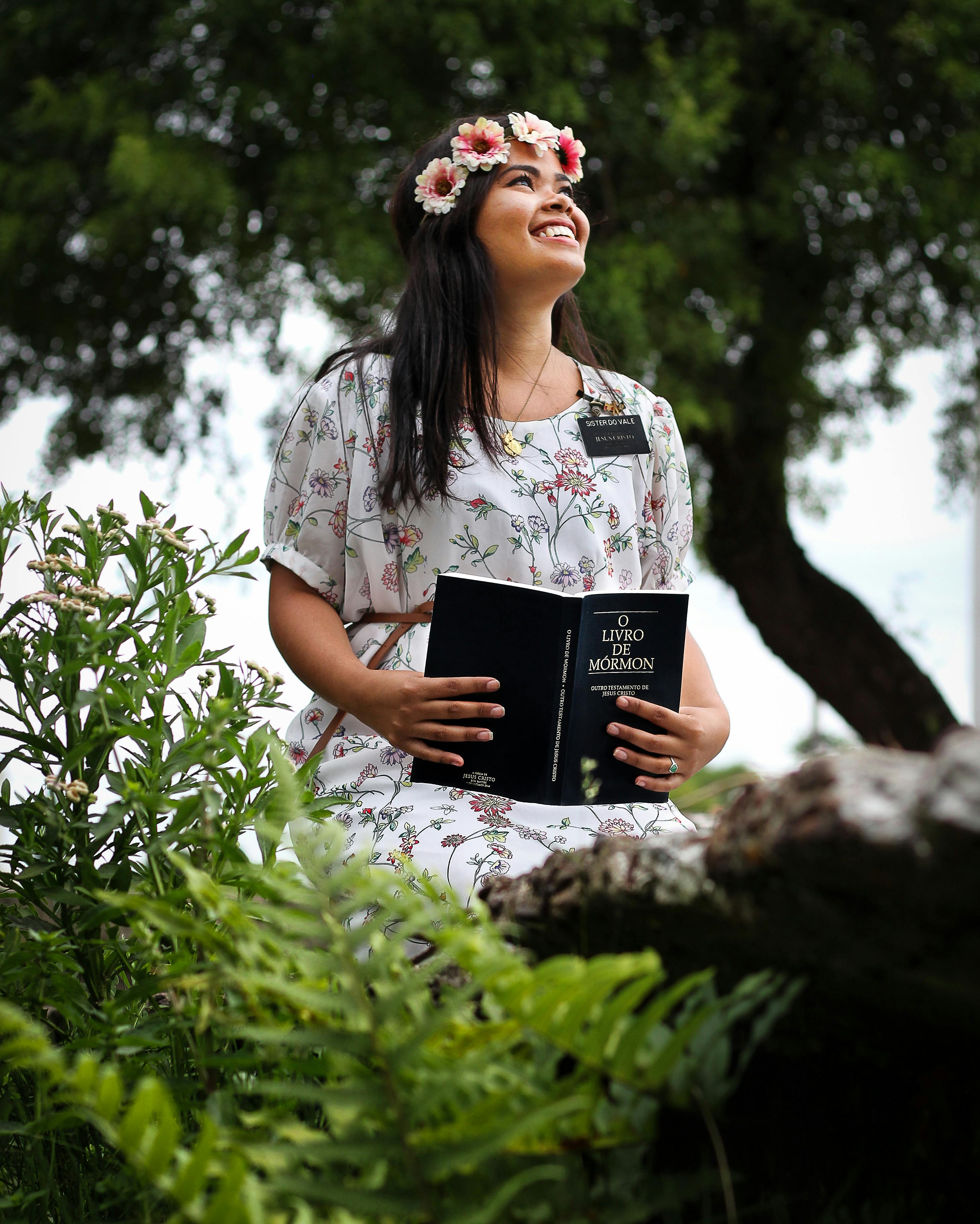 Woman Wearing White Floral Dress Holding Book · Free Stock Photo