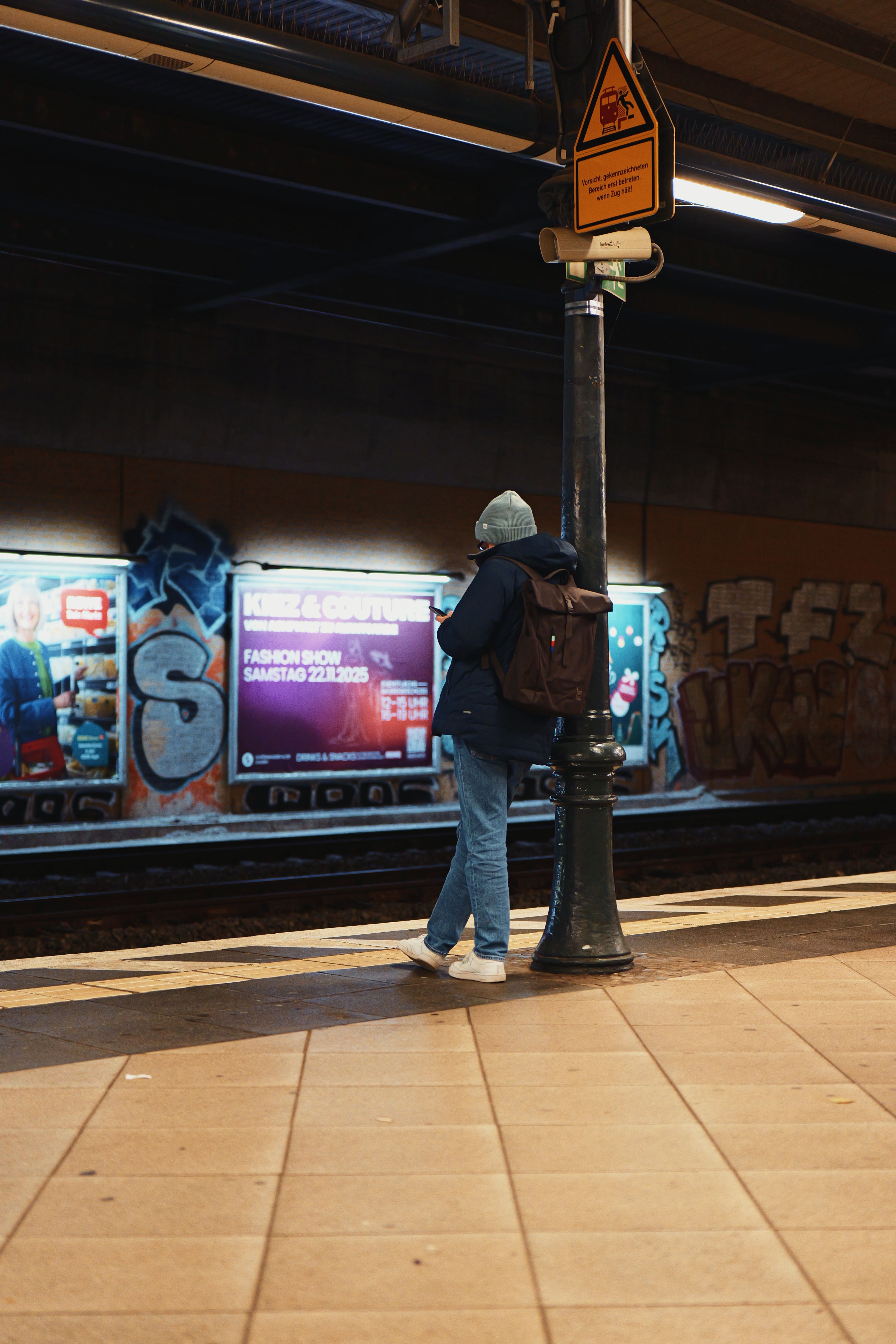 Young Man Waits Alone at Berlin Train Station · Free Stock Photo