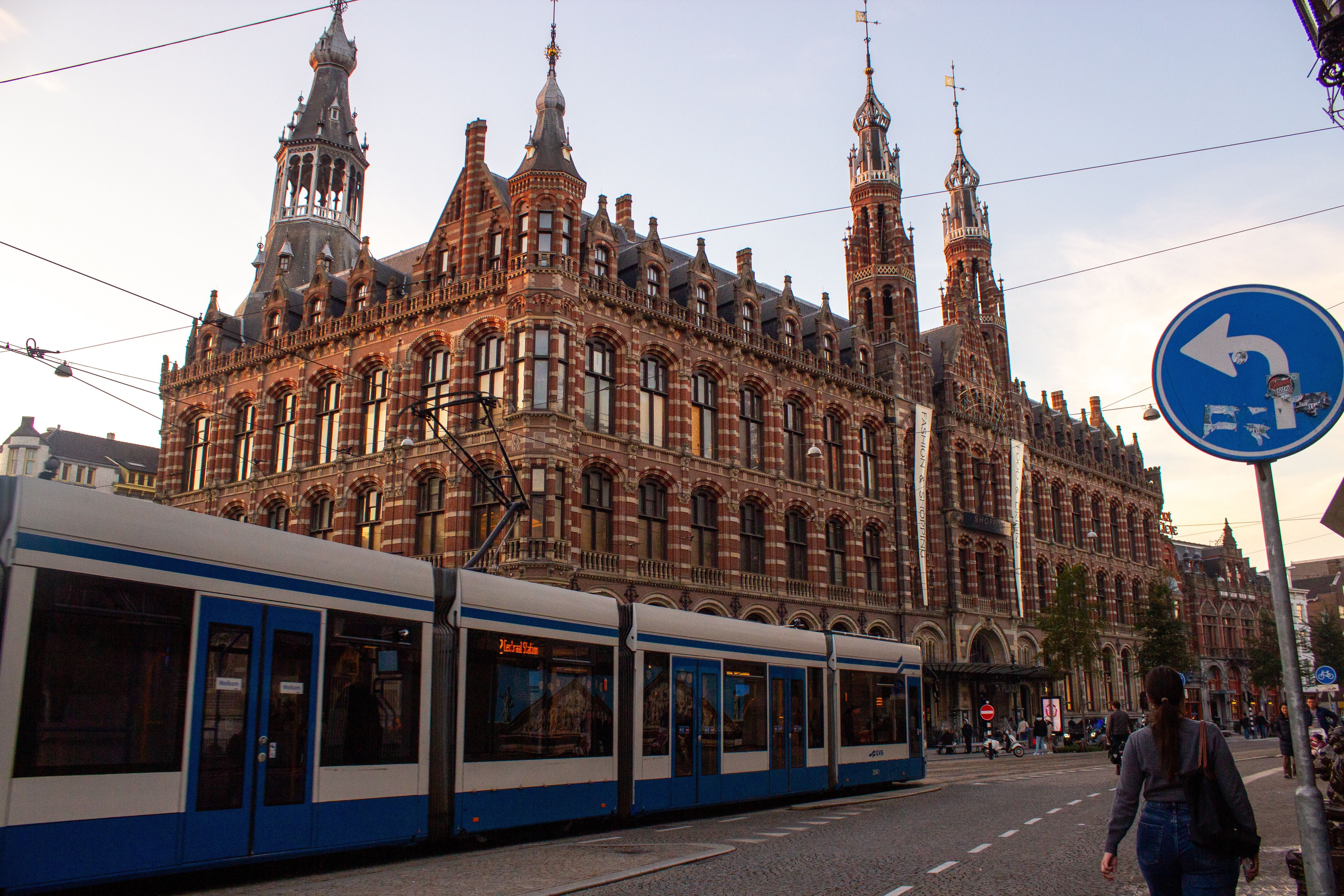 Historic Amsterdam Building with Tram at Sunset · Free Stock Photo