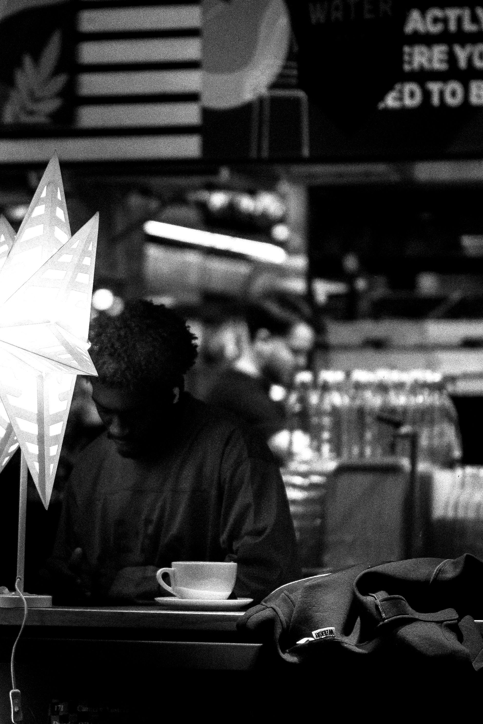 Moody Cafe Scene with Star-Shaped Lamp · Free Stock Photo