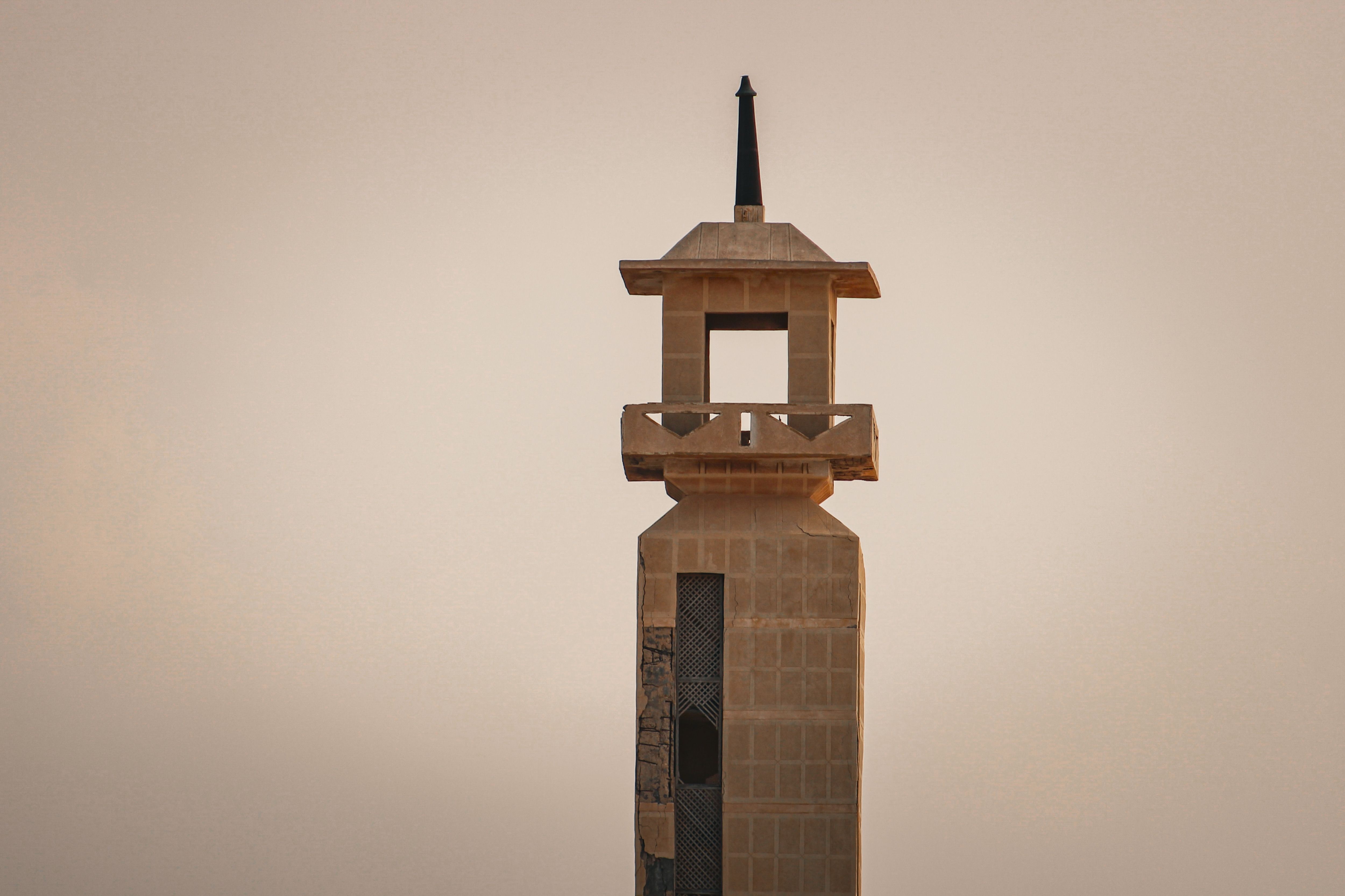 Minimalist Tower against Beige Sky · Free Stock Photo