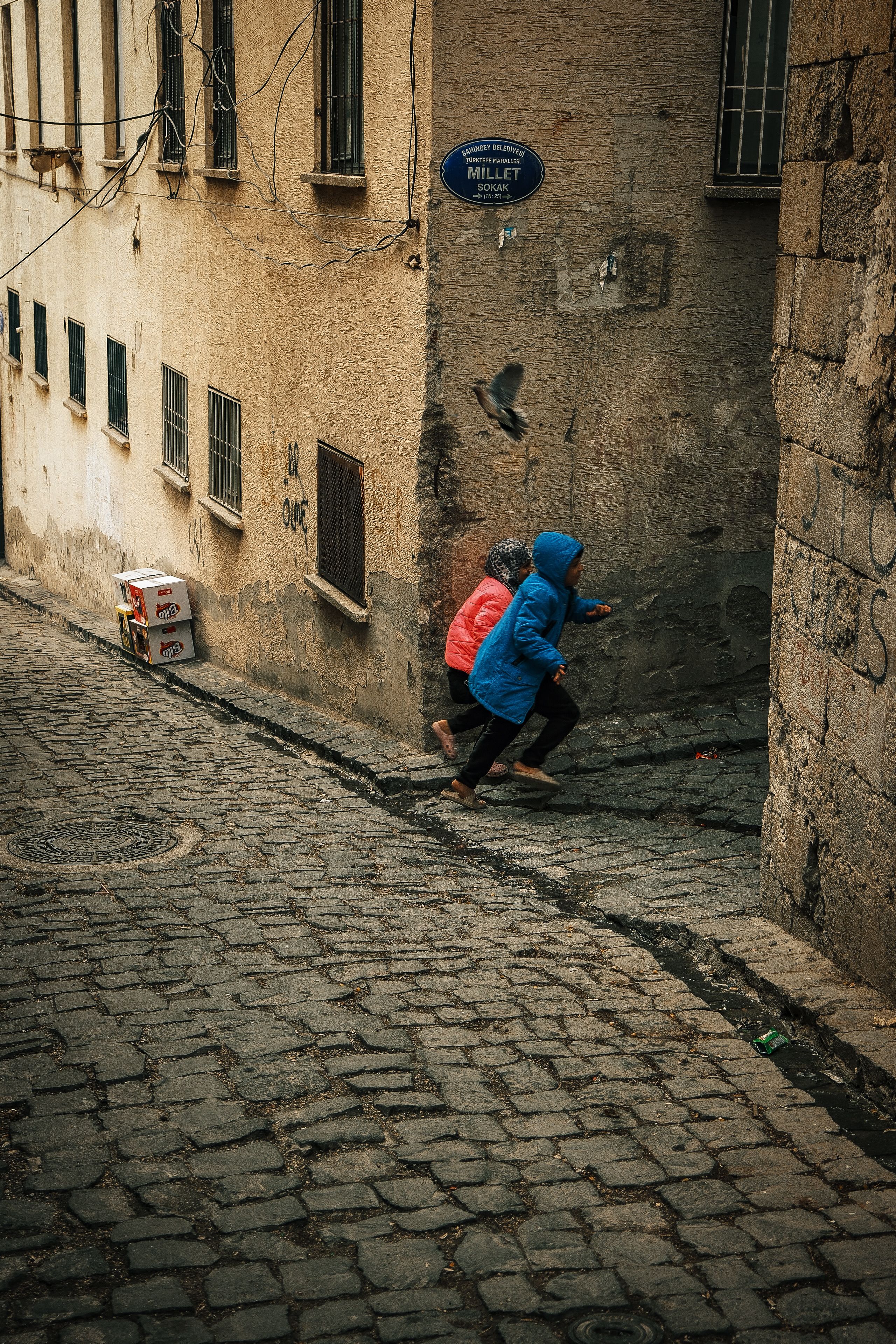 Children Running on Cobblestone Street in Alley · Free Stock Photo