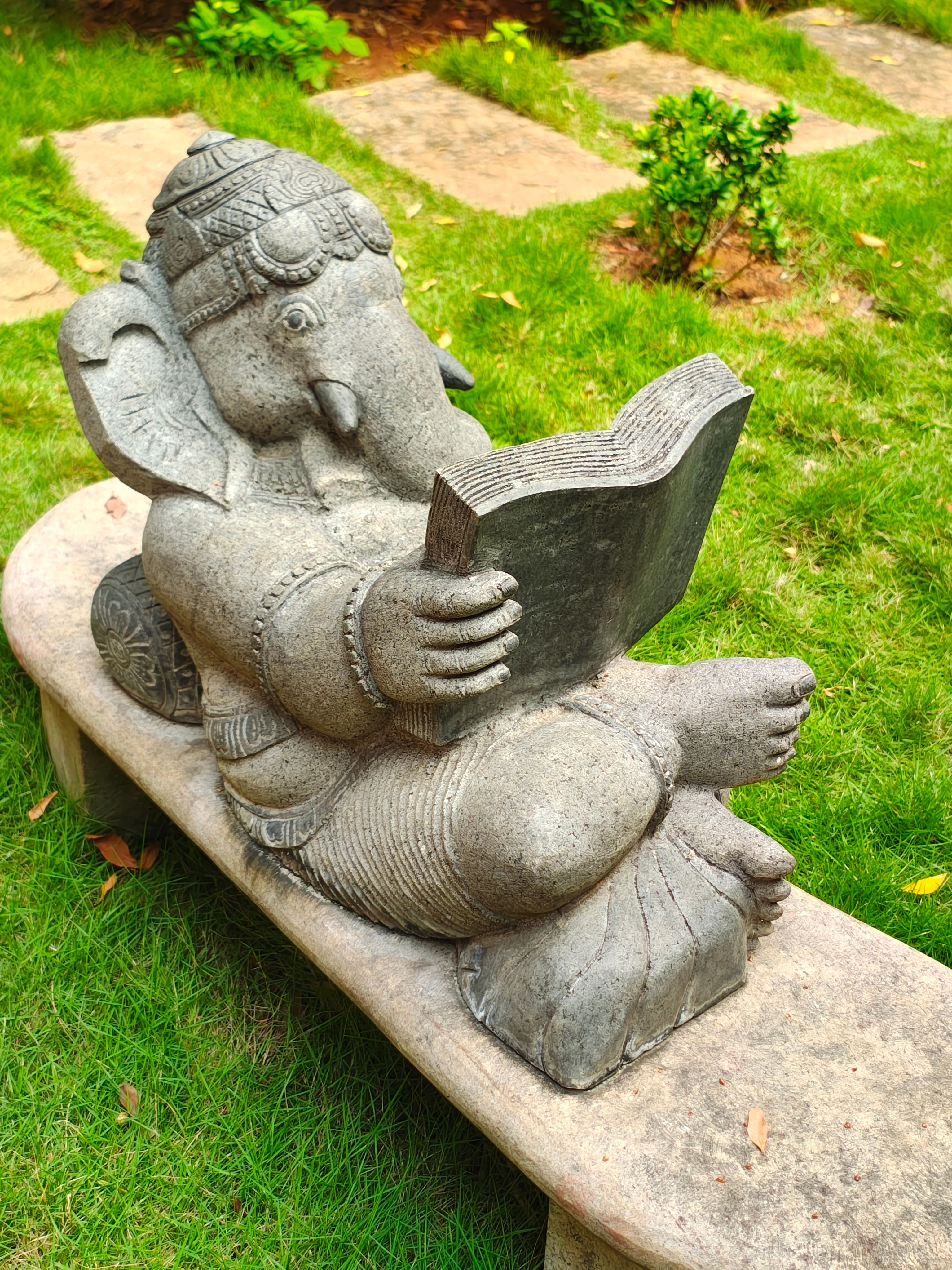 Statue of Ganesha Reading Book in Garden Setting · Free Stock Photo