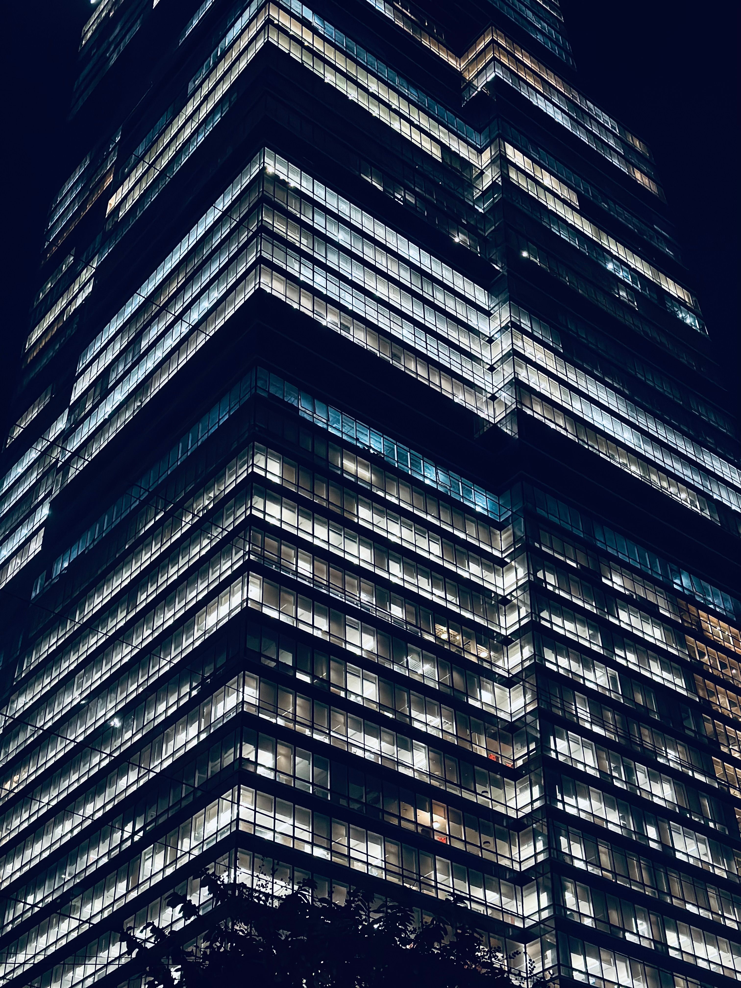 Modern Skyscraper at Night with Illuminated Windows · Free Stock Photo