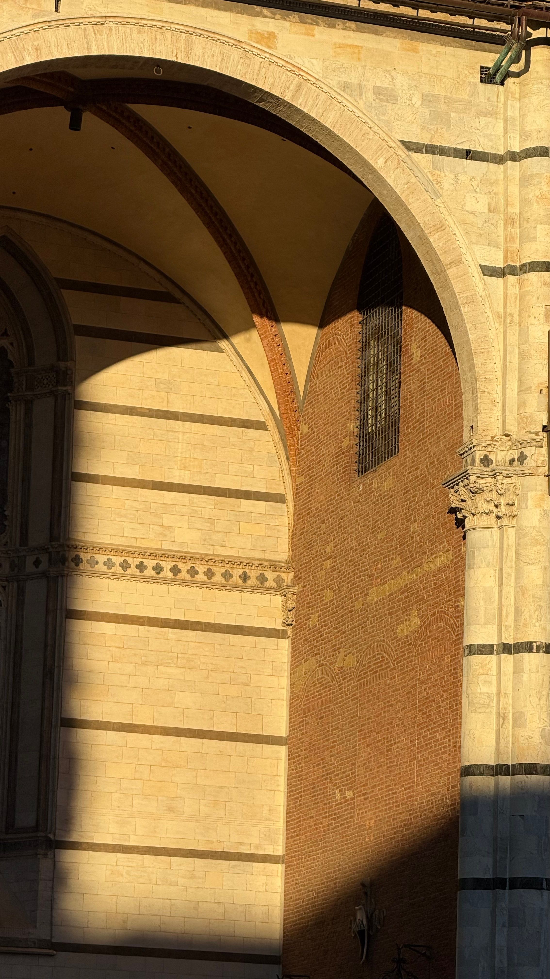 Sunlit Cathedral Archway with Dramatic Shadows · Free Stock Photo