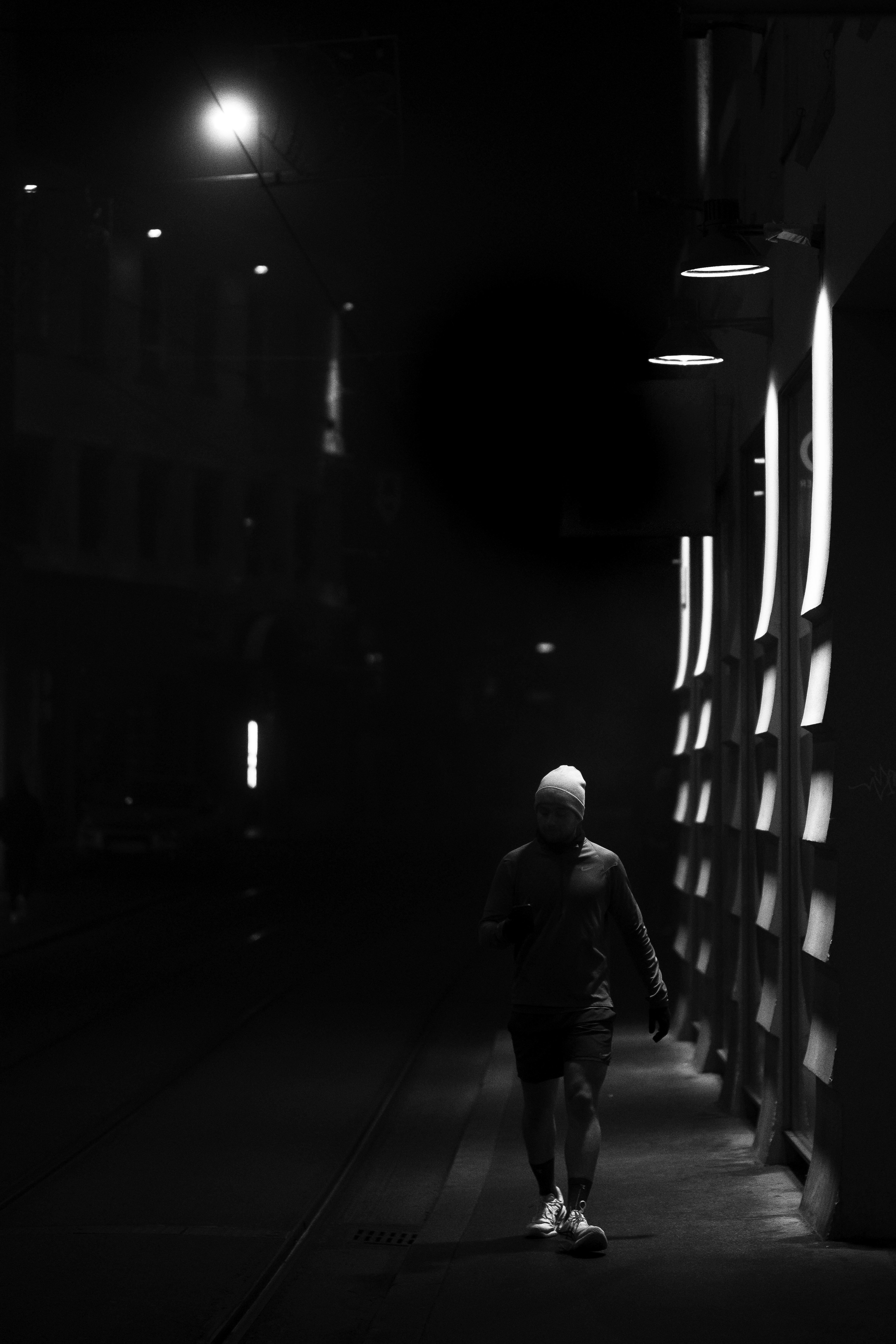 Moody Nighttime Urban Street Walker in Black and White · Free Stock Photo