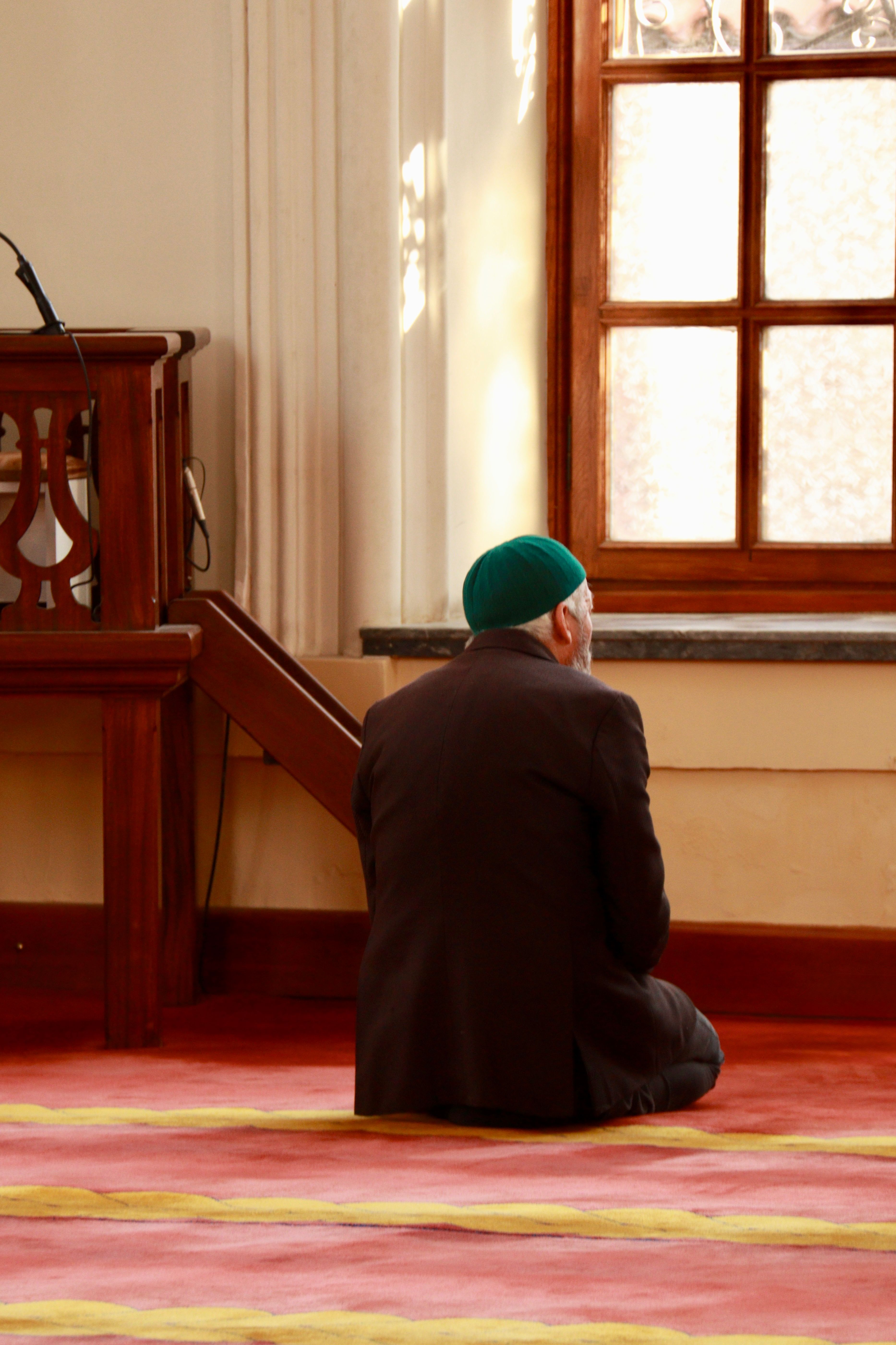 Elderly Man Praying Indoors in Quiet Reflection · Free Stock Photo