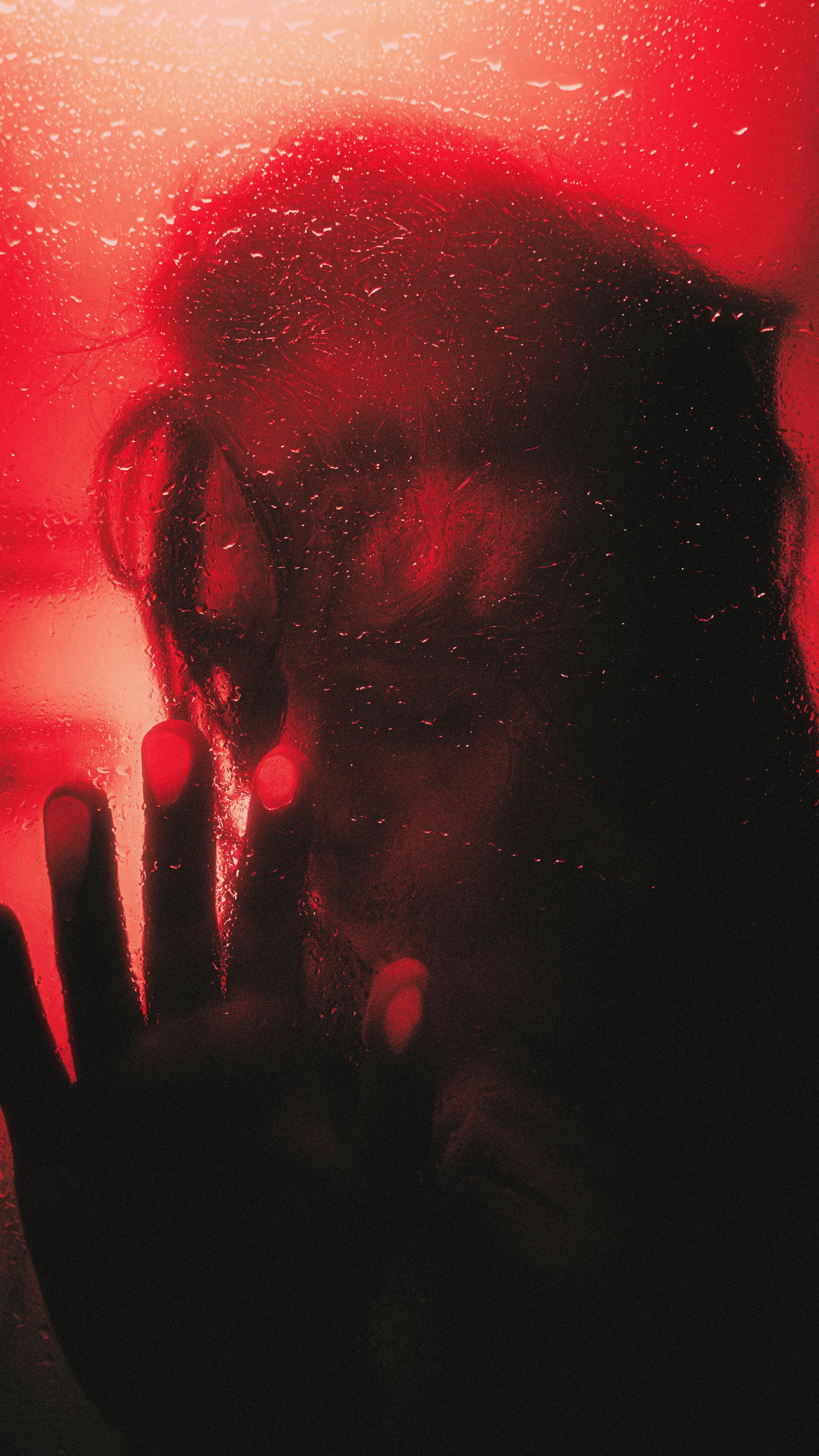 Moody Silhouette Behind Wet Glass with Red Light · Free Stock Photo