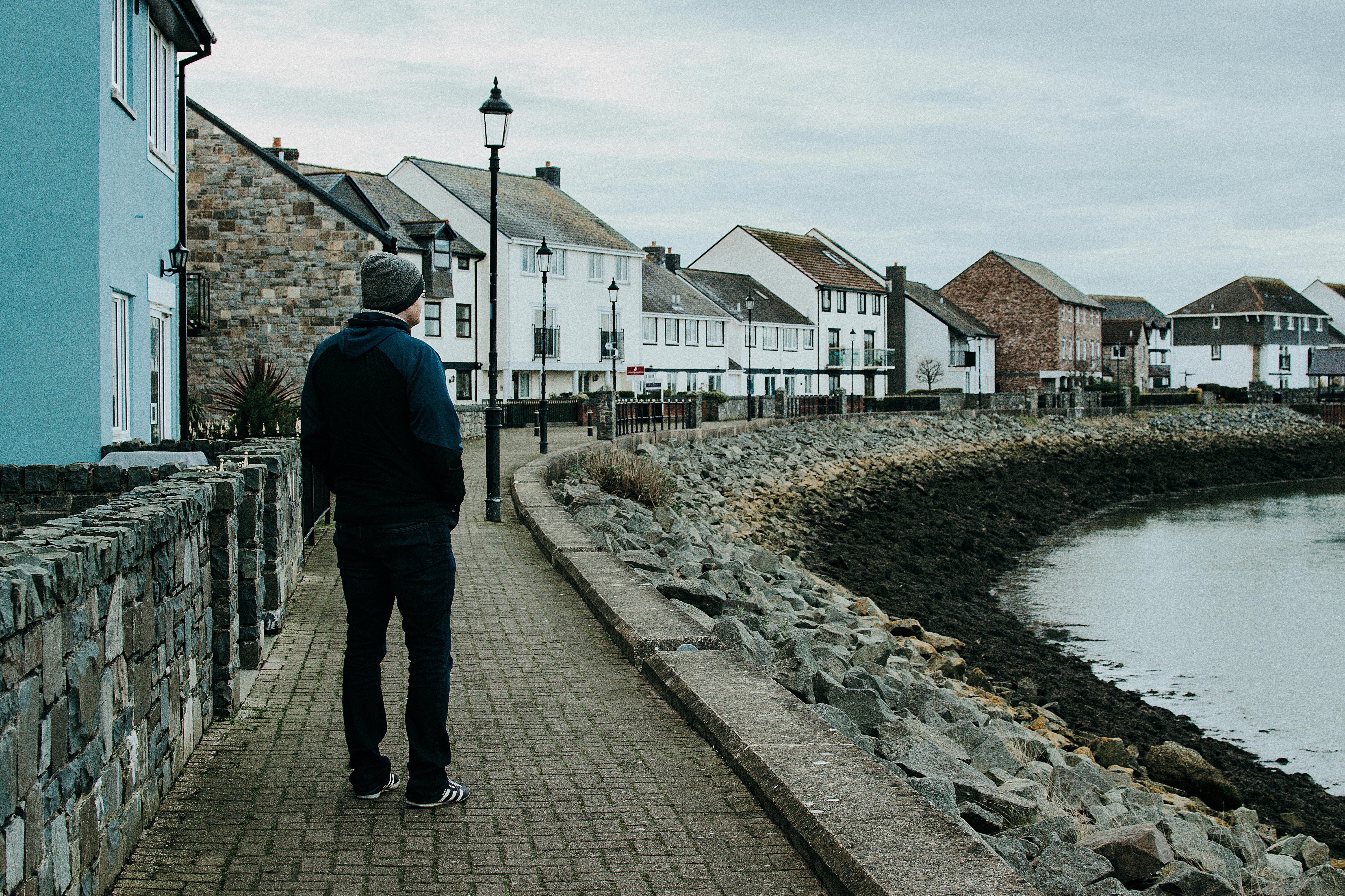 Person Standing On Walkway · Free Stock Photo