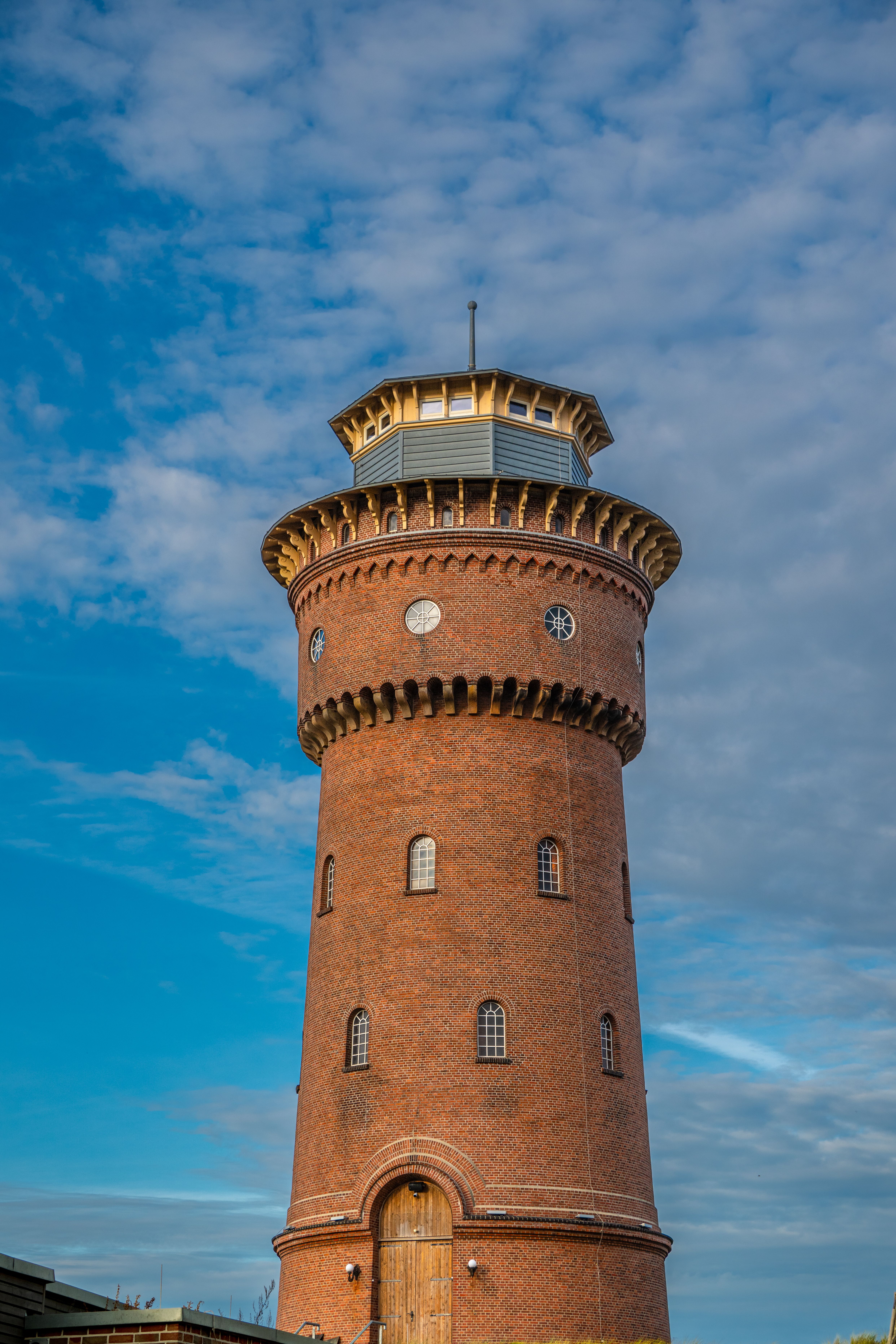 Historic Brick Water Tower Against Blue Sky · Free Stock Photo