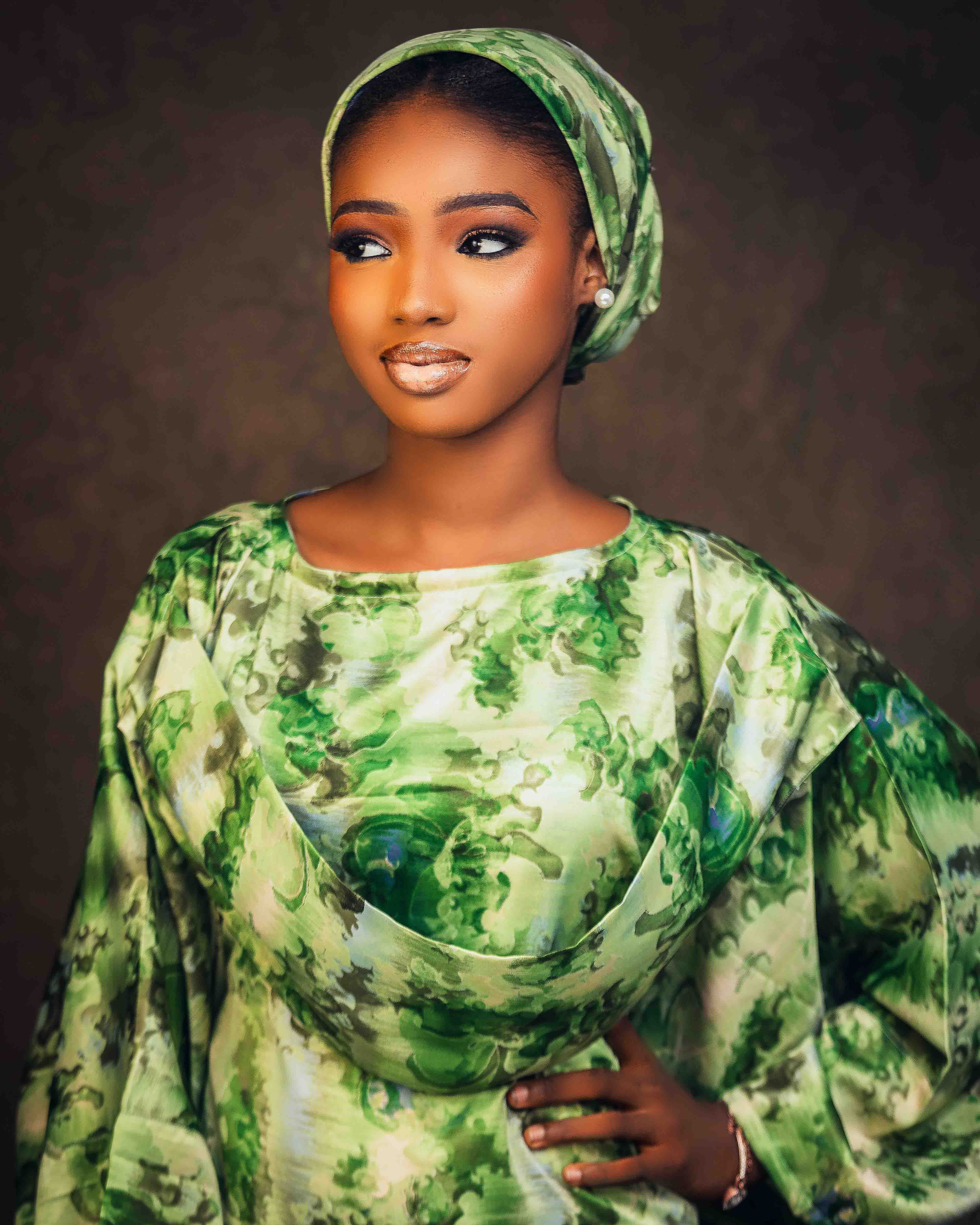 Elegant Portrait of Woman in Green Traditional Attire · Free Stock Photo