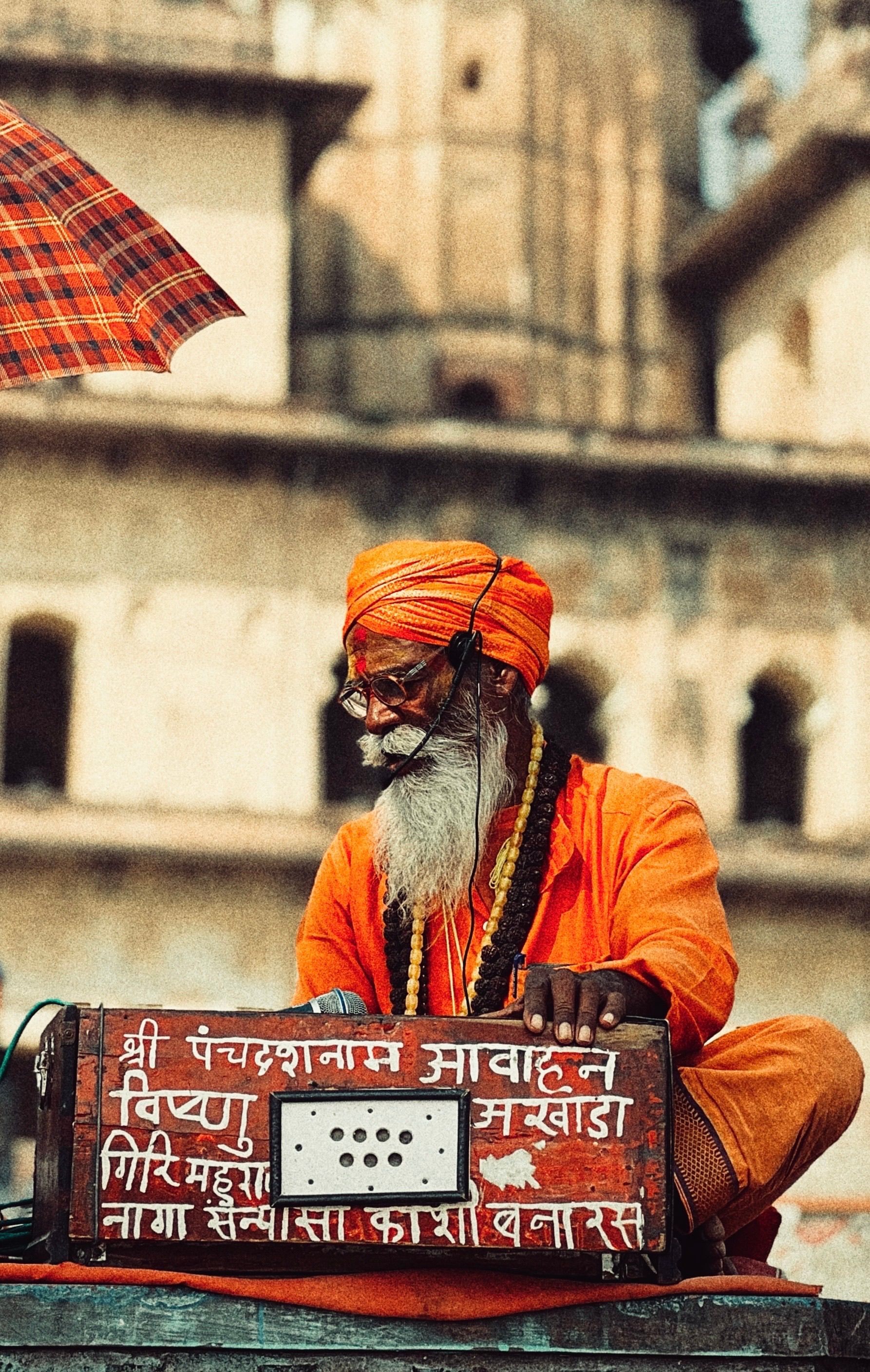 Hindu Priest Playing Harmonium in Traditional Attire · Free Stock Photo