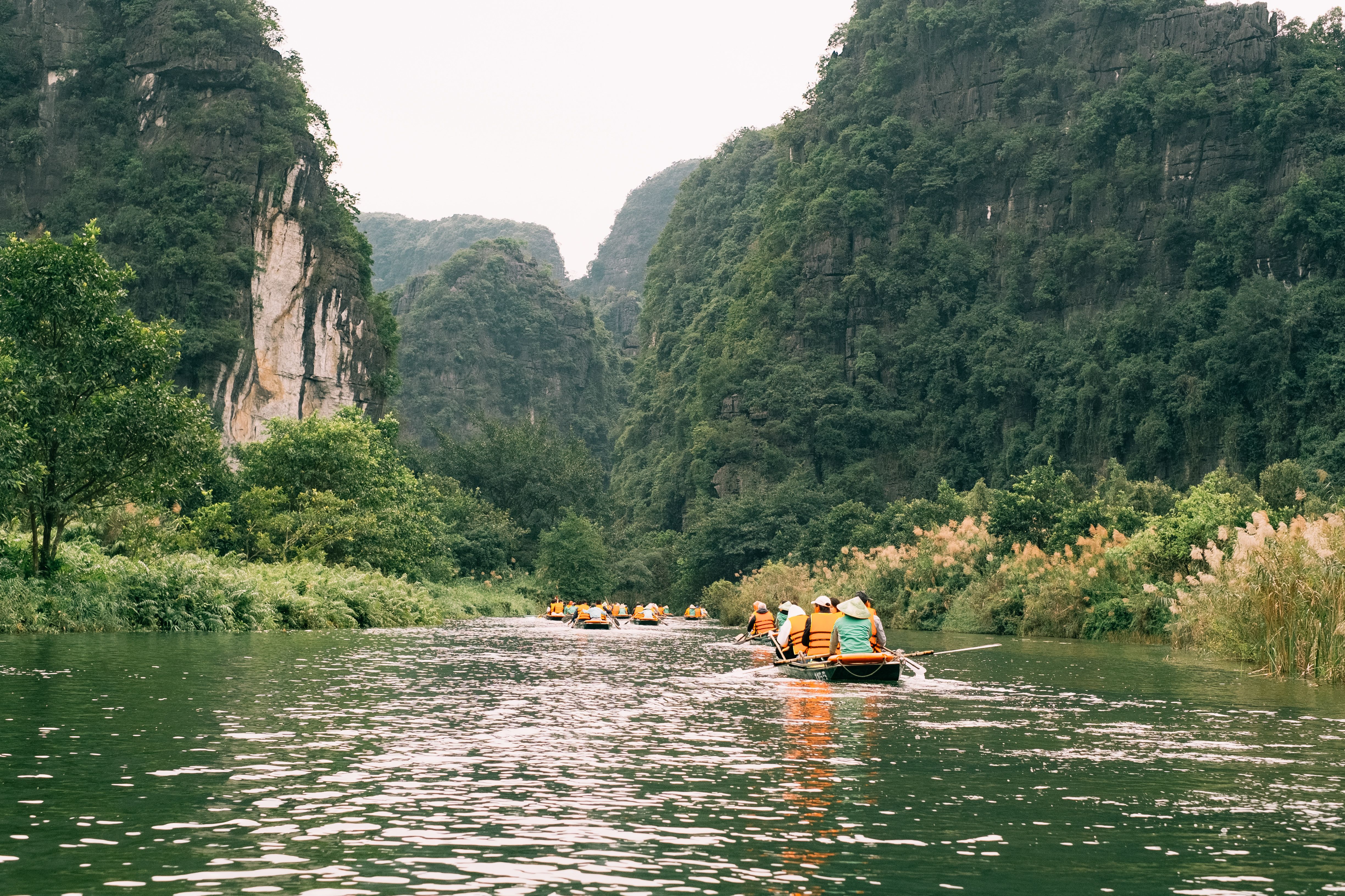 Kayakers Enjoy Scenic River in Lush Valley · Free Stock Photo