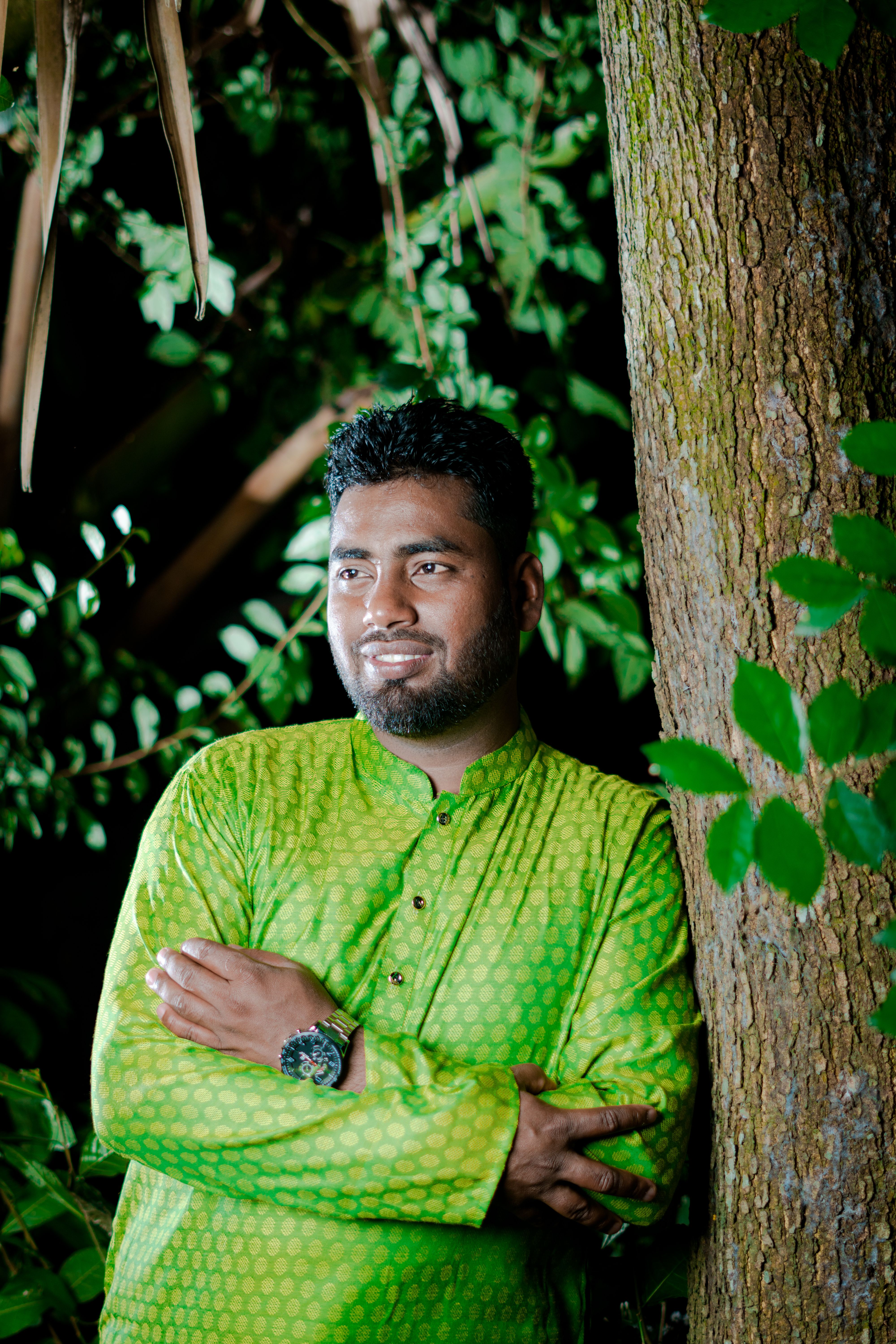 Man in Green Traditional Garment Posing Outdoors · Free Stock Photo