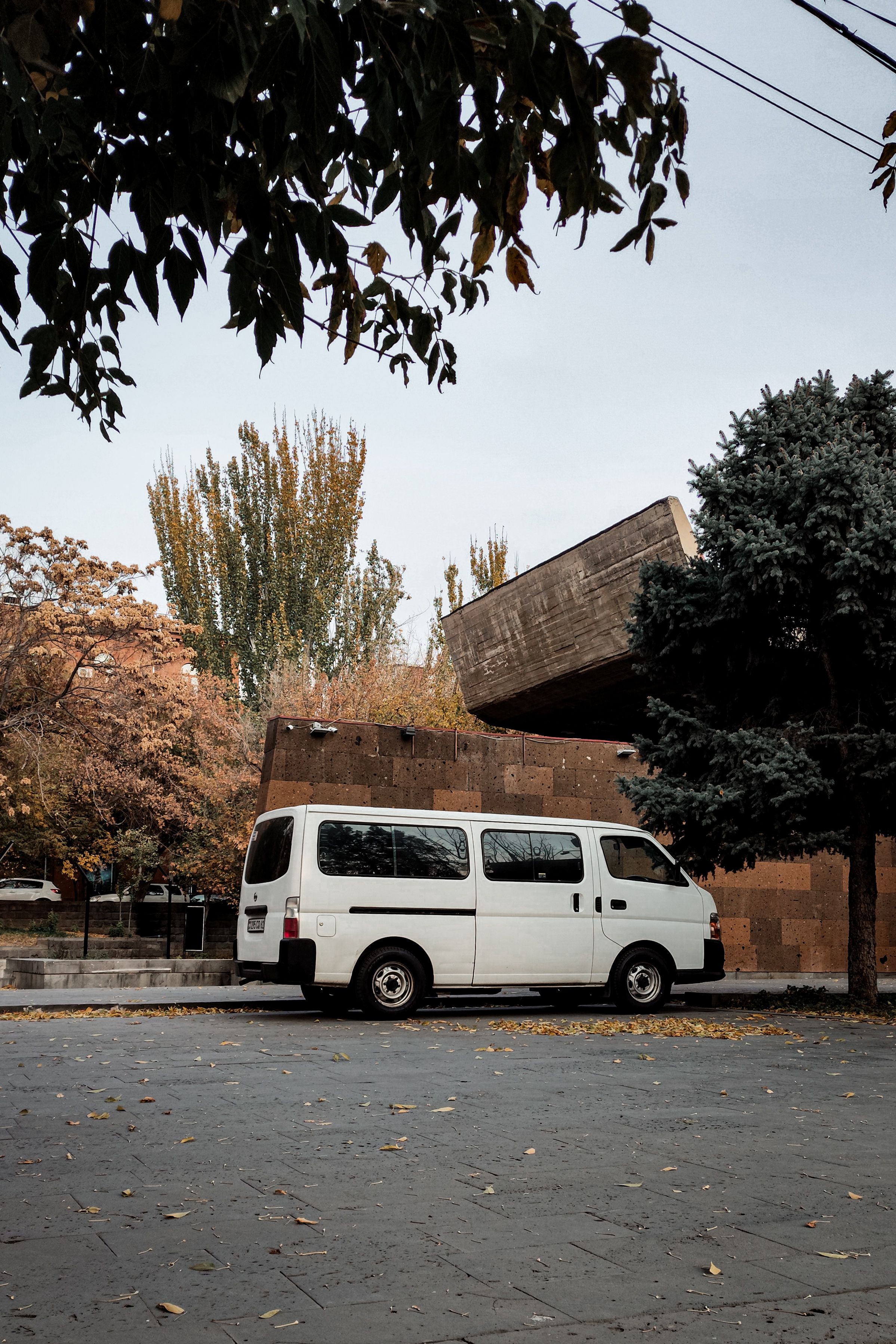 White Van Parked by Modern Structure in Yerevan · Free Stock Photo