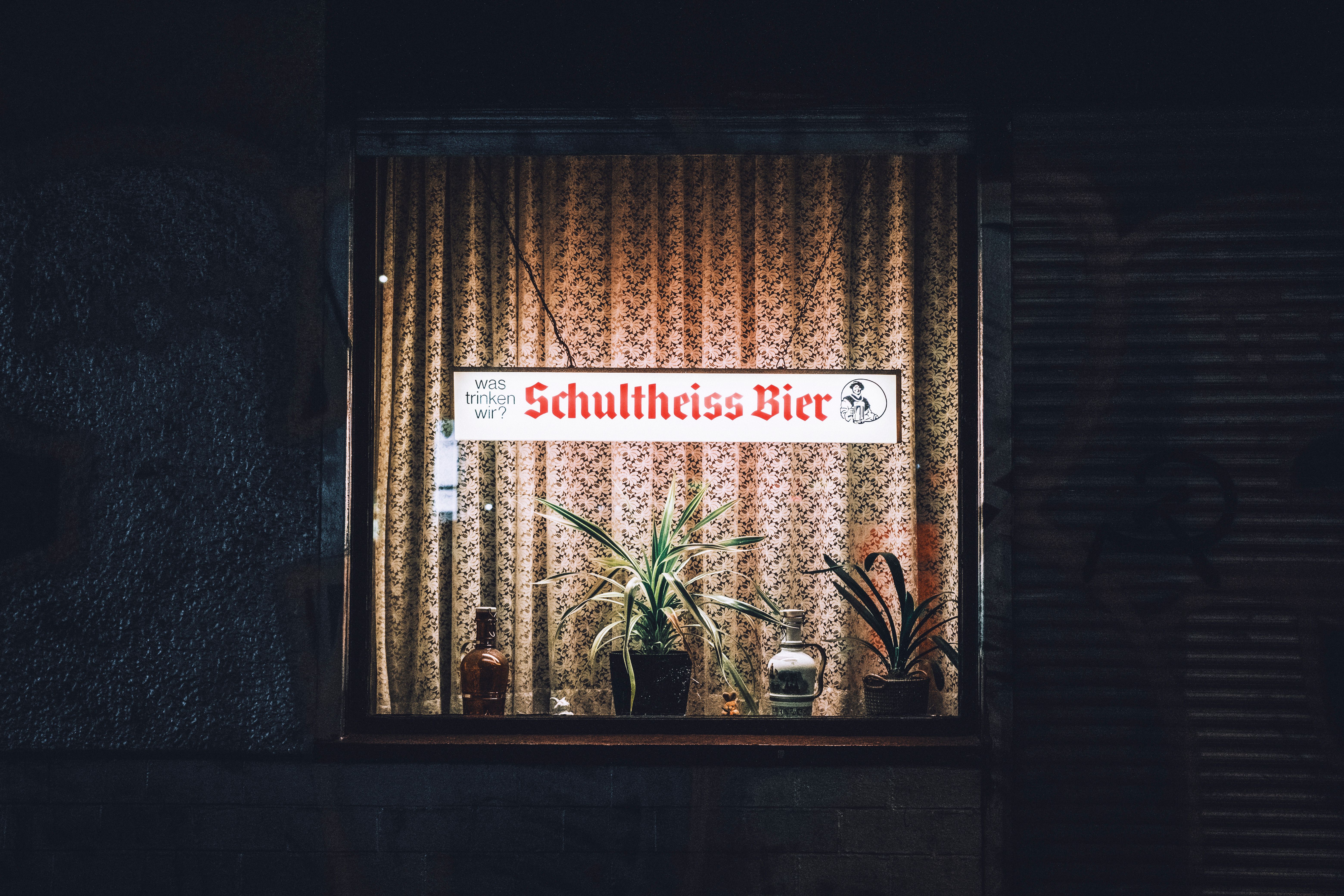 Illuminated Pub Window in Berlin at Night · Free Stock Photo