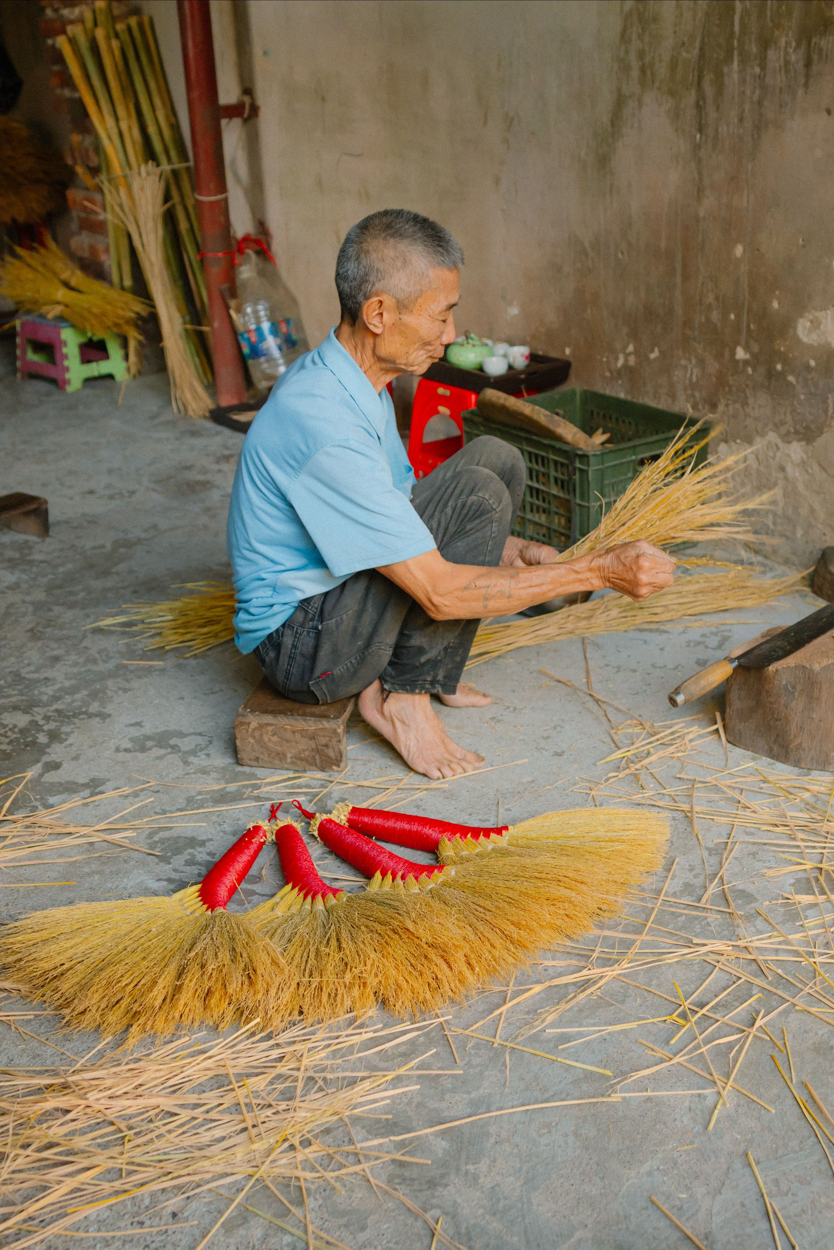 Elderly Man Crafting Traditional Brooms Indoors · Free Stock Photo