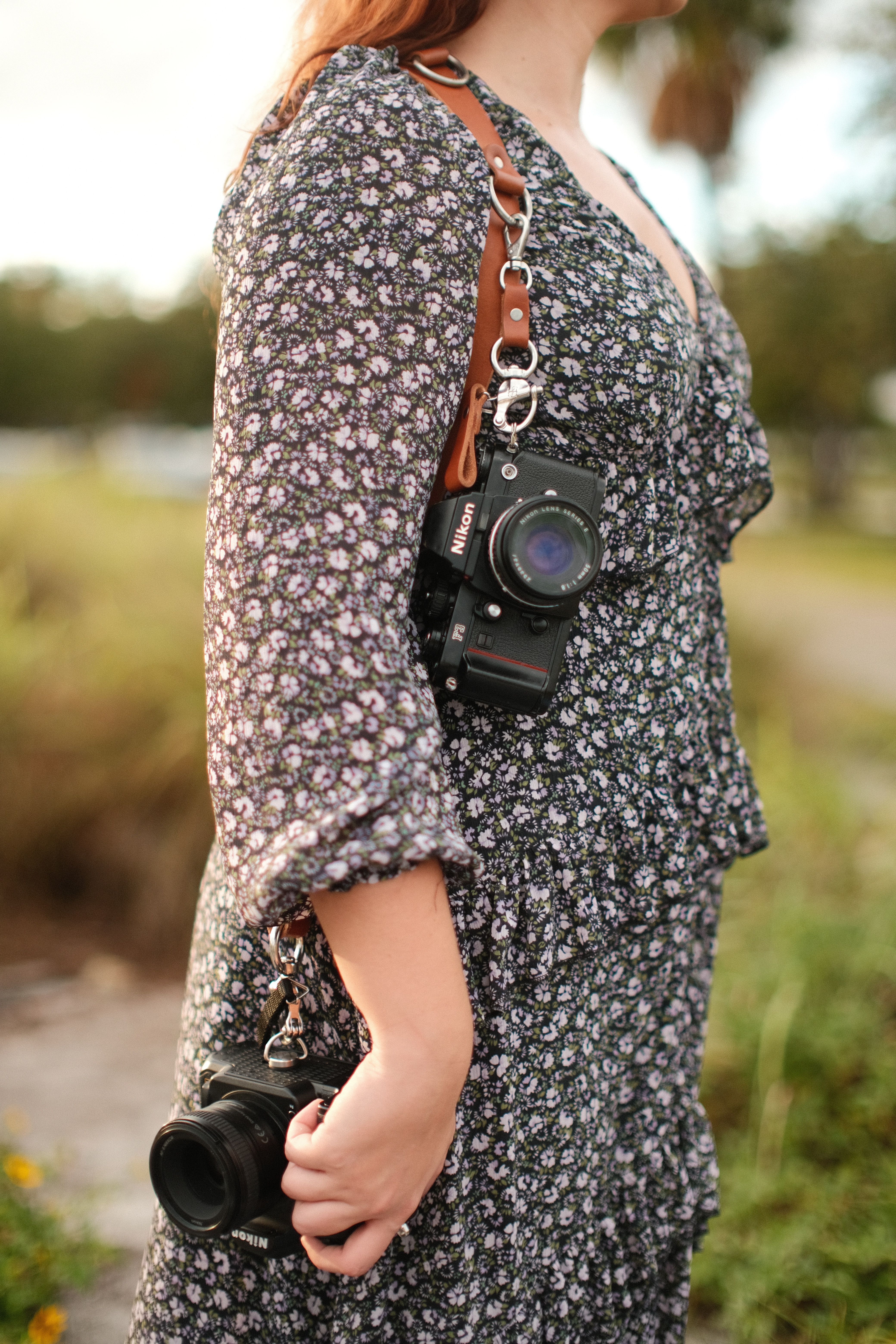 Woman Photographer Holding Two Cameras Outdoors · Free Stock Photo