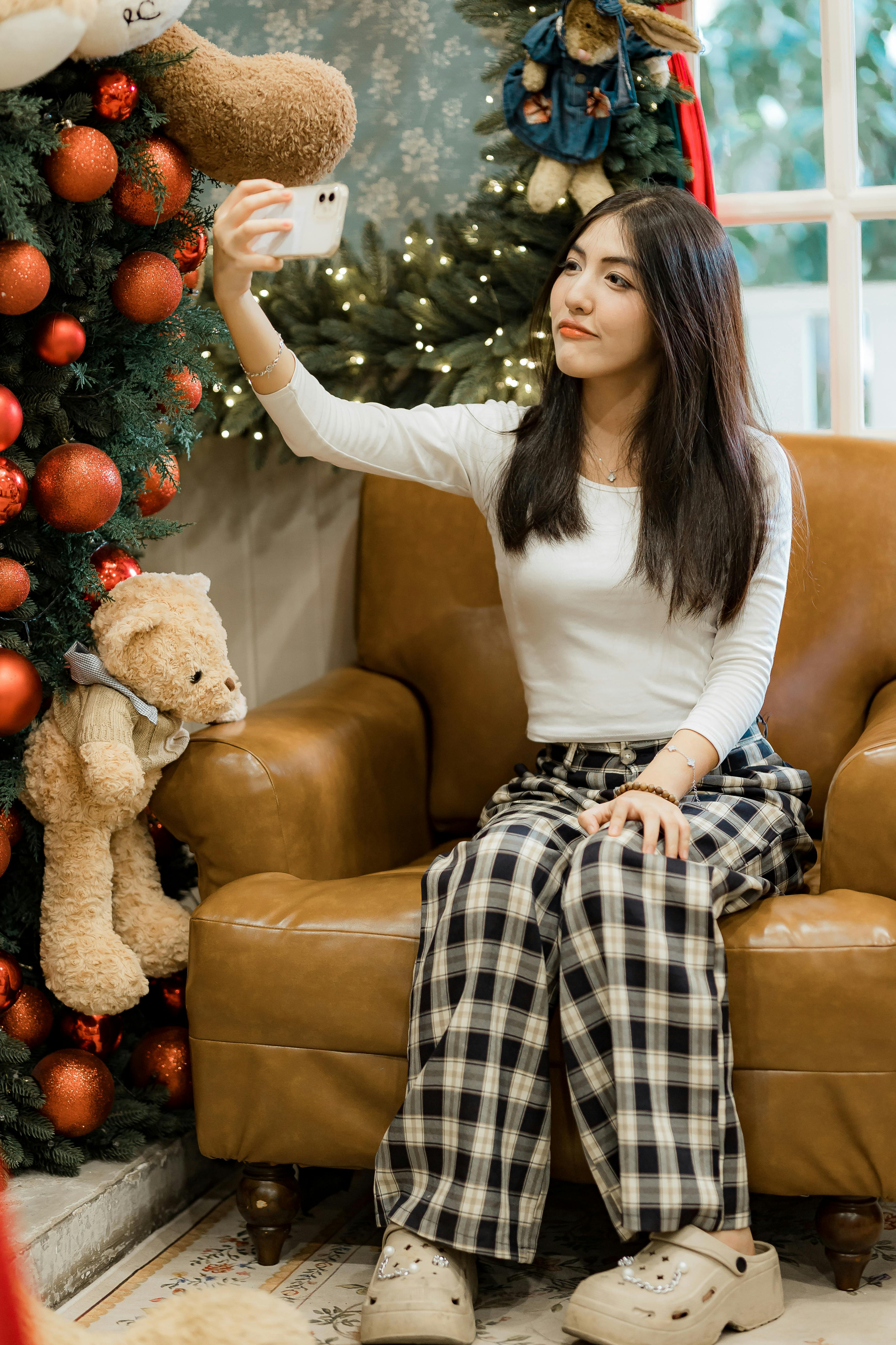 Young Woman Taking Selfie With Christmas Decorations · Free Stock Photo