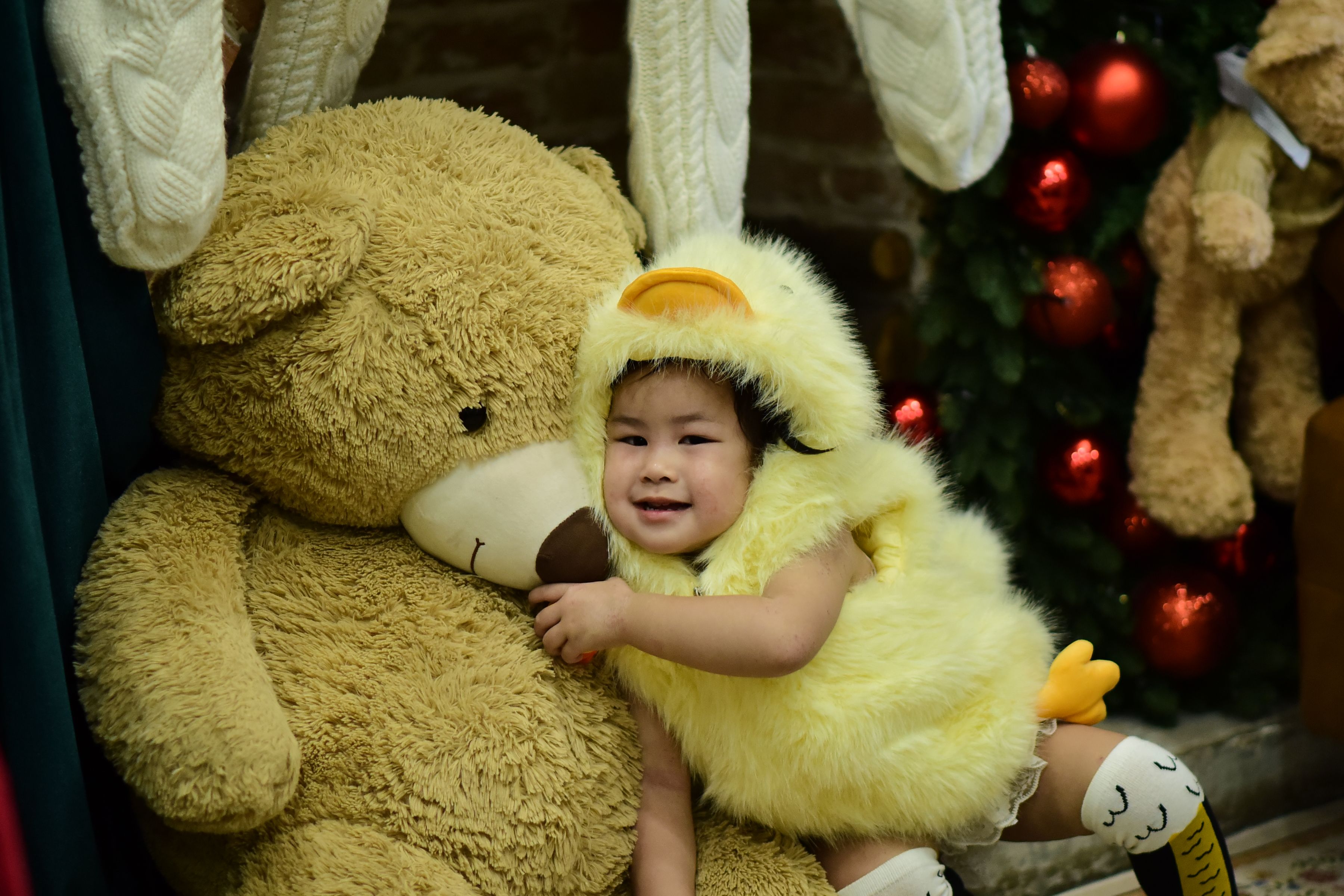 Child in Cute Duck Costume with Teddy Bear · Free Stock Photo