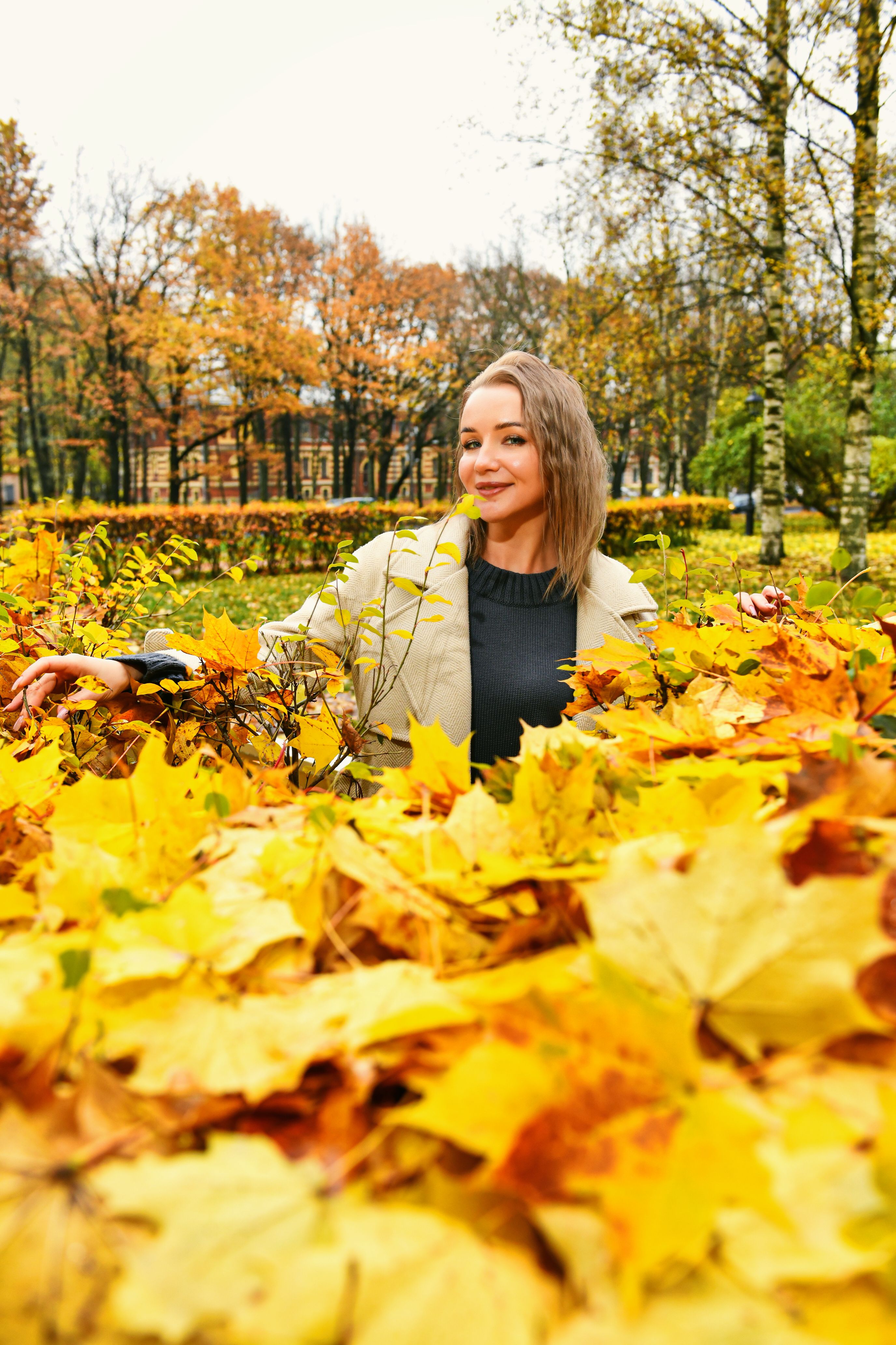 Woman Enjoying Autumn Leaves in Park Setting · Free Stock Photo