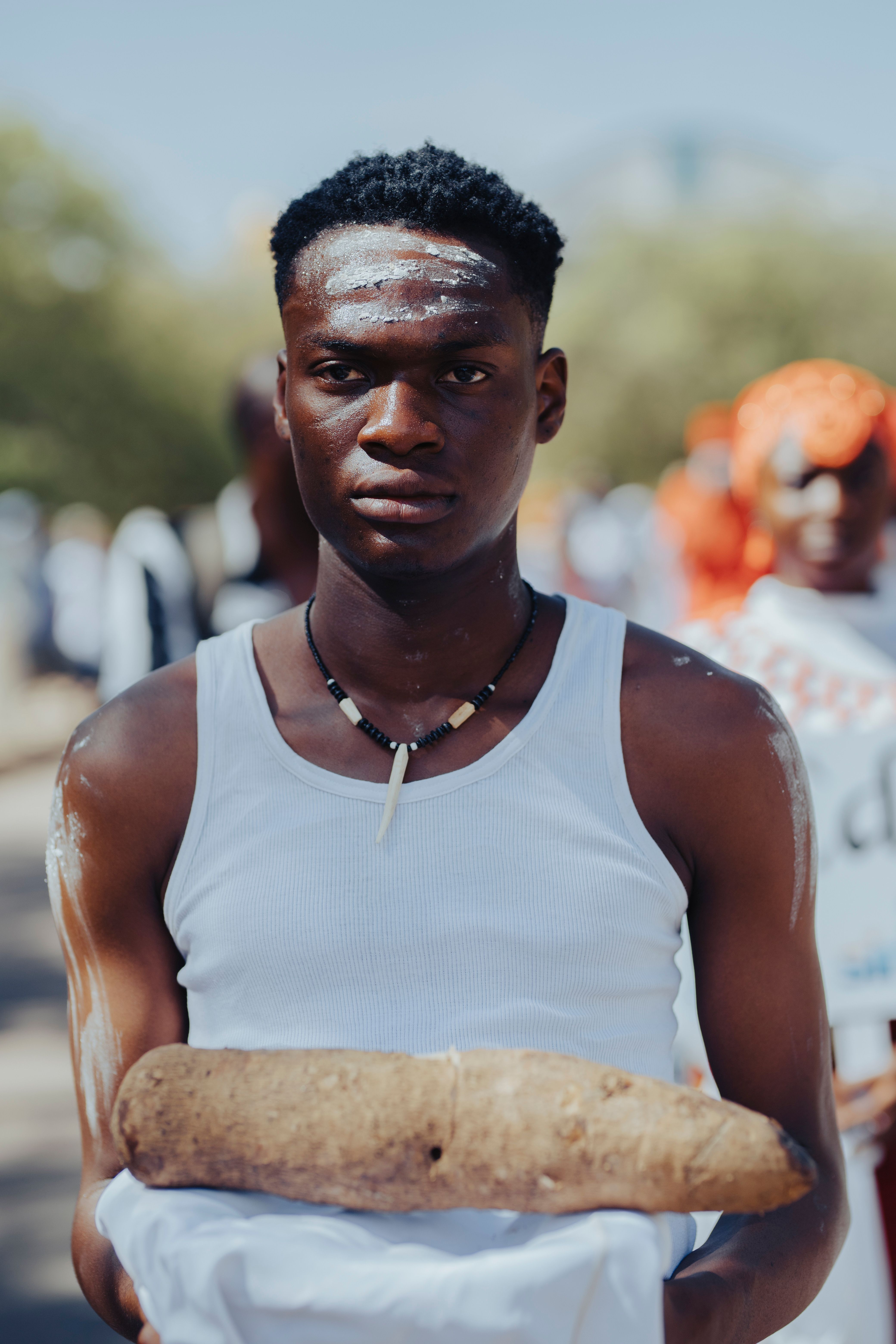 Portrait of Man Holding Yam Outdoors · Free Stock Photo