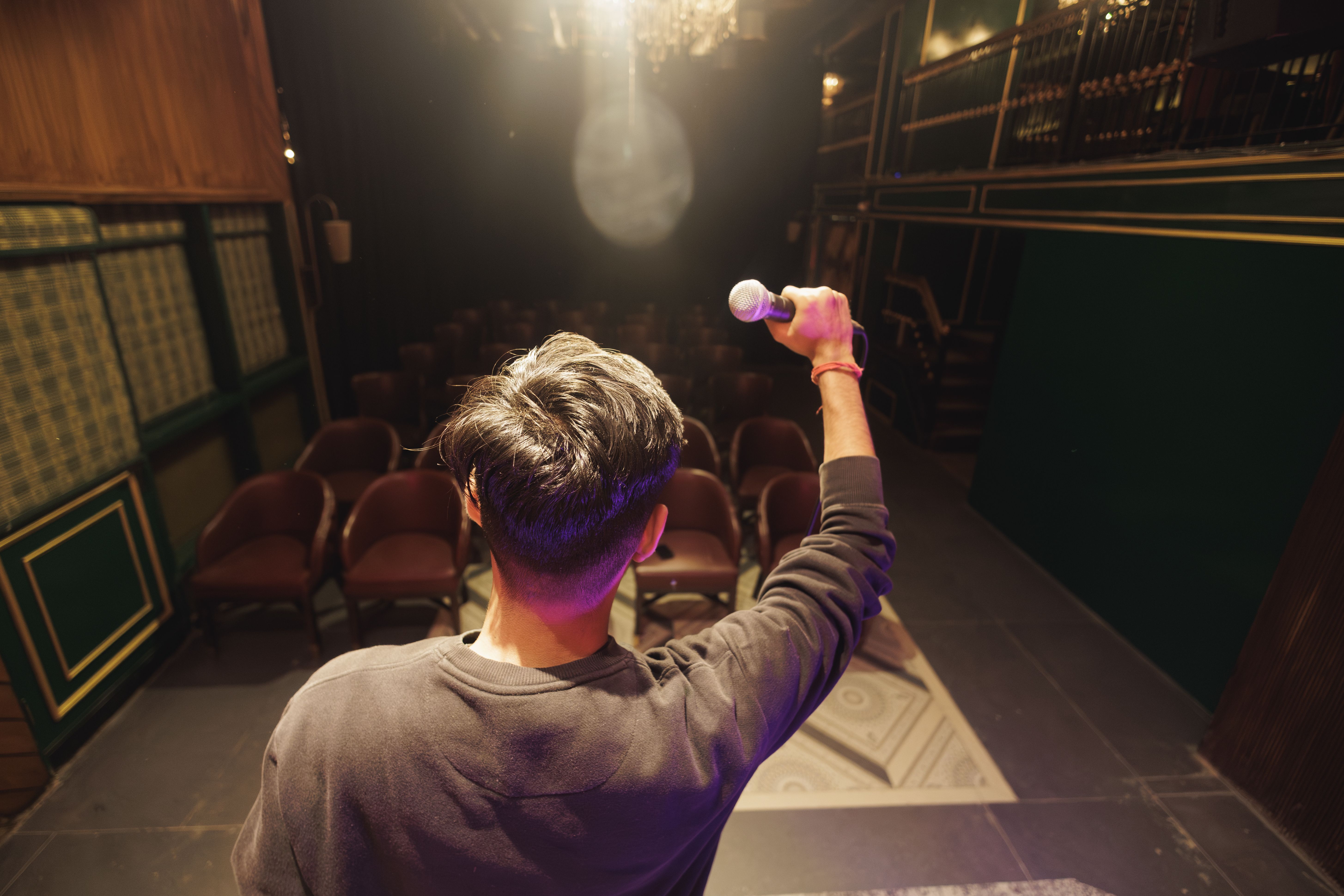 Young Man Preparing for Performance on Stage · Free Stock Photo