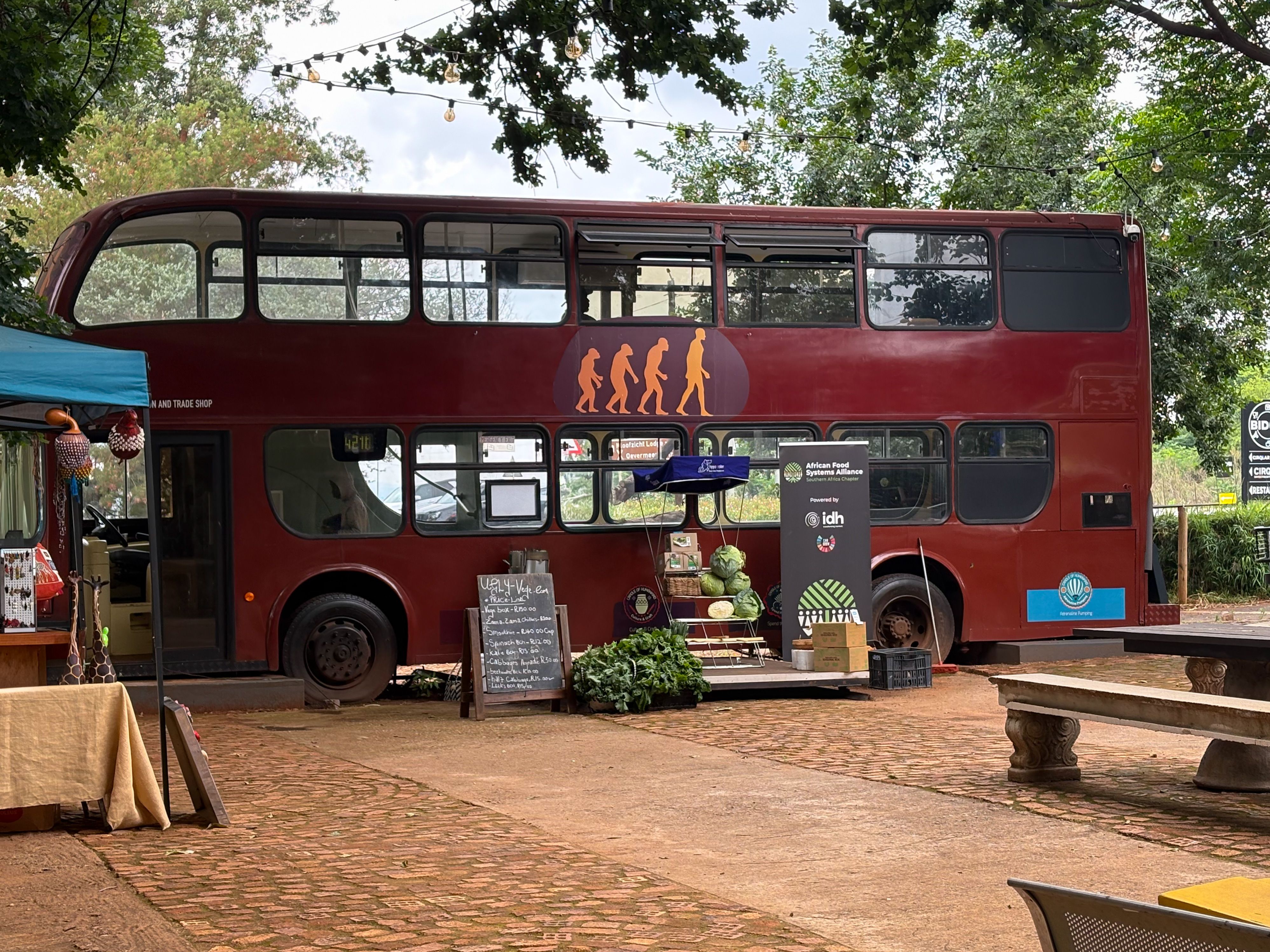 Unique Double-Decker Bus Cafe in Outdoor Market · Free Stock Photo