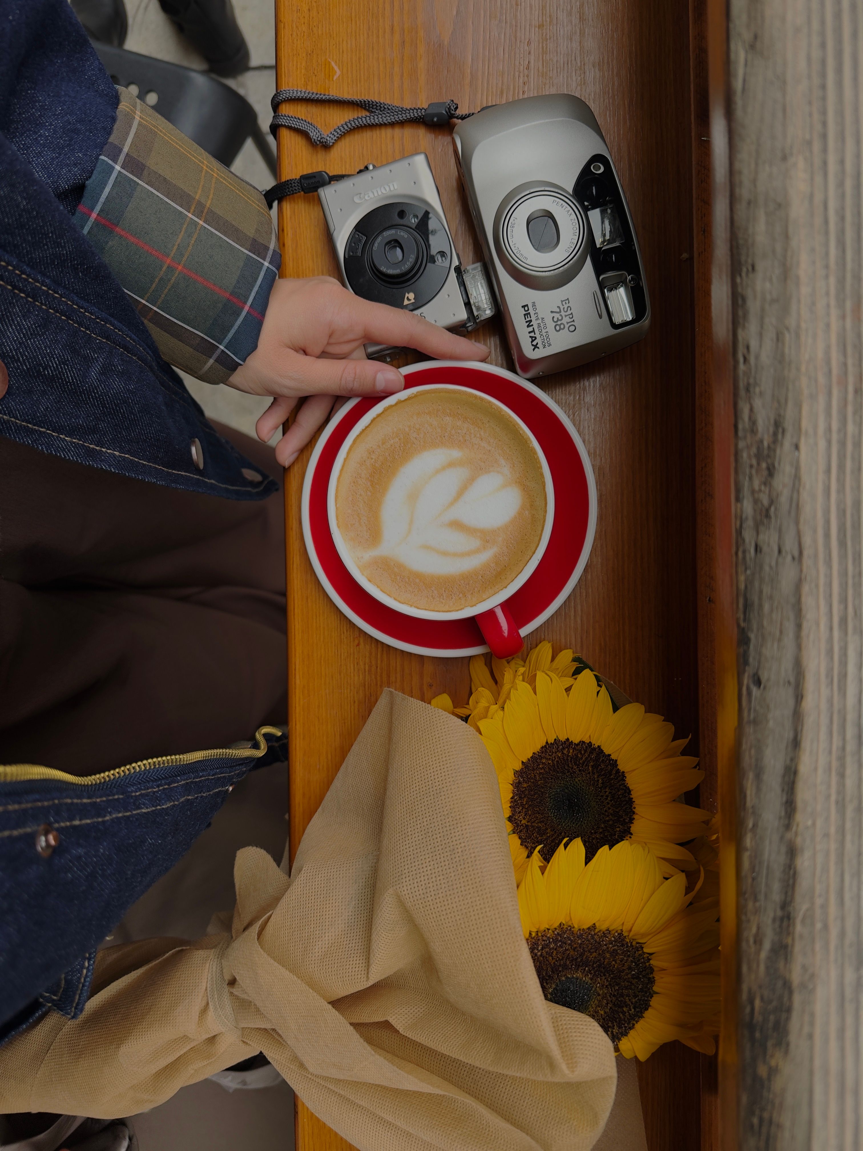 Cozy Coffee Moment with Vintage Cameras and Sunflowers · Free Stock Photo