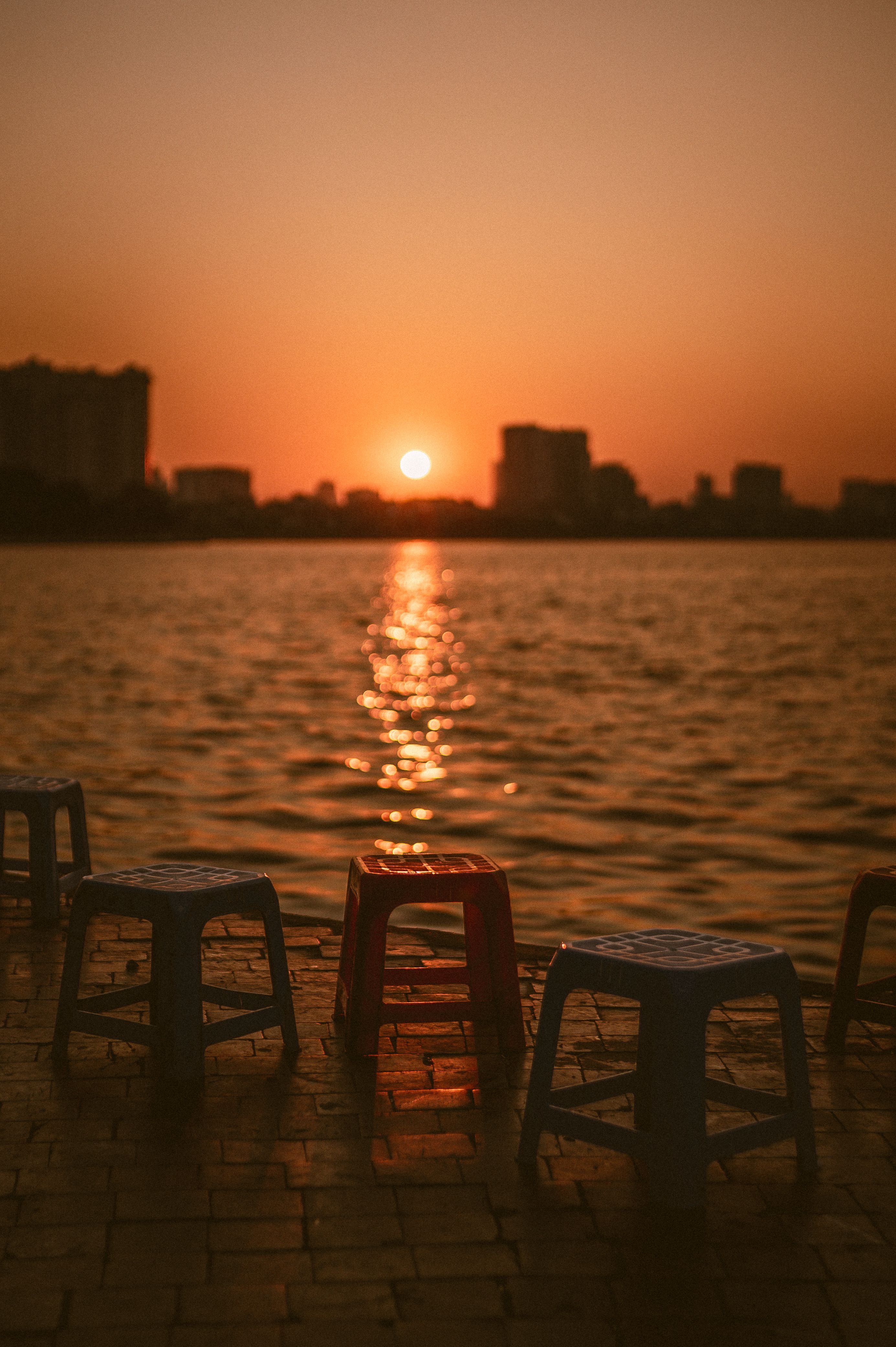 Sunset Over Cityscape with River Reflection · Free Stock Photo