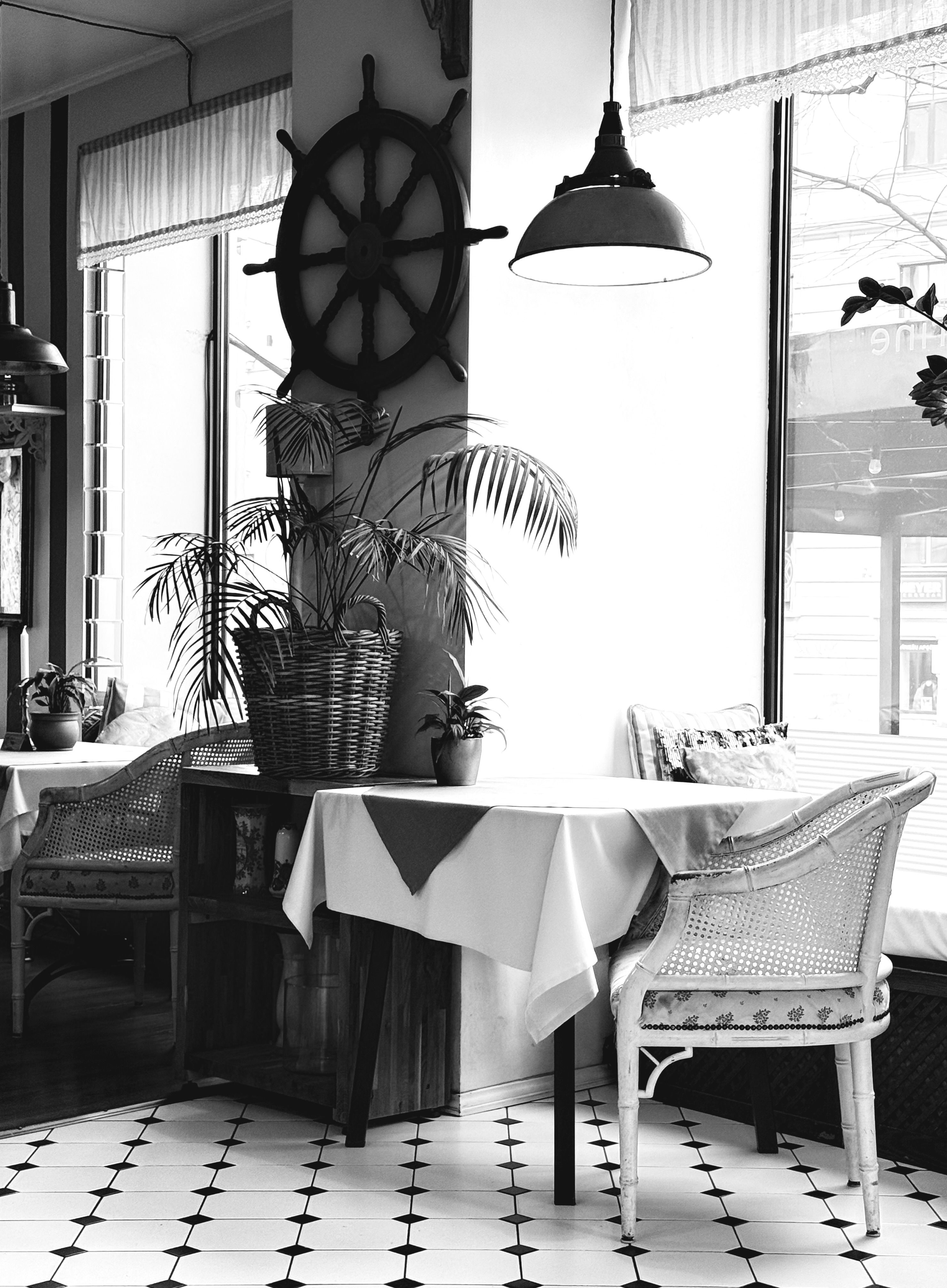 Cozy Black and White Cafe Interior with Nautical Decor · Free Stock Photo