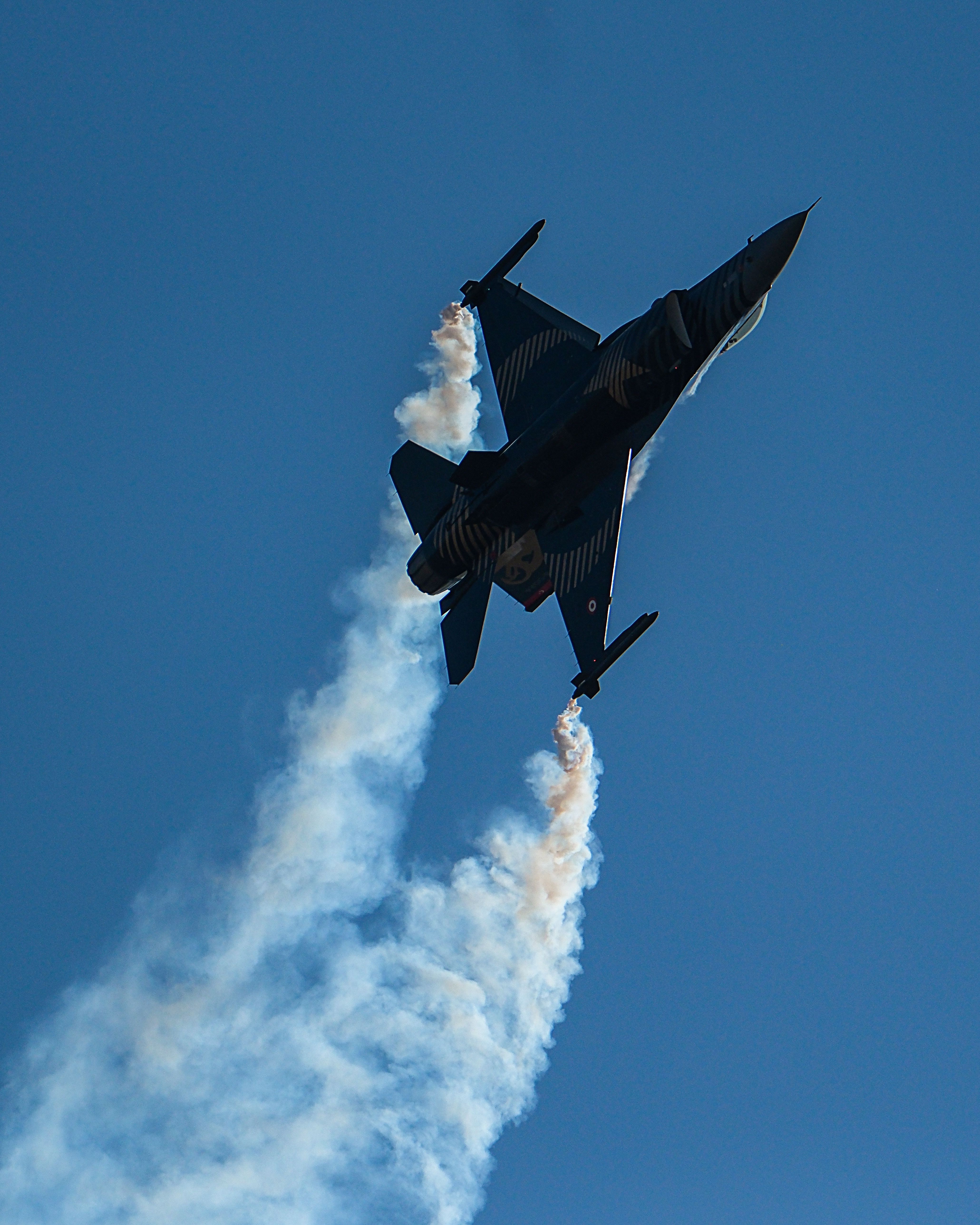 Fighter Jet Performing Aerobatic Maneuver in Blue Sky · Free Stock Photo